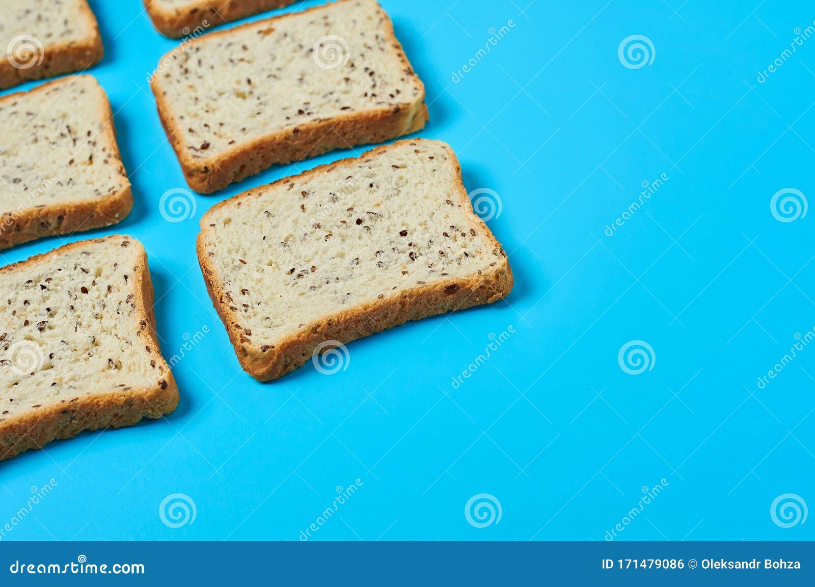 Rows of Square Pieces of Bread with Seeds for Toast Lies on Blue Table ...