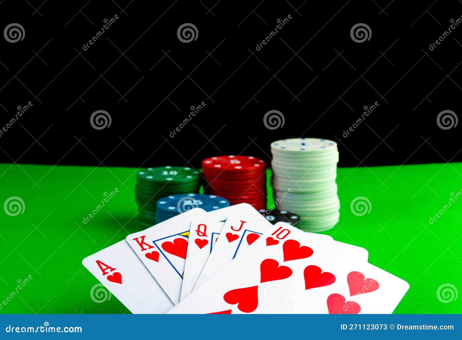 Royal Flush Cards and Poker Chips in Stacks on a Green Table Stock ...
