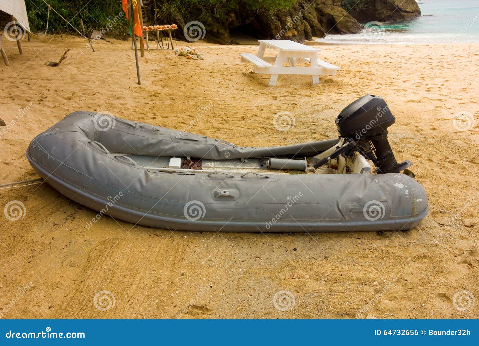 A rubber dinghy on a beach stock photo. Image of shabby - 64732656