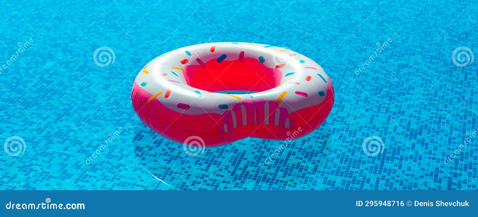 Rubber Inflatable Donut with Caramel Sprinkles on the Surface of Clean ...