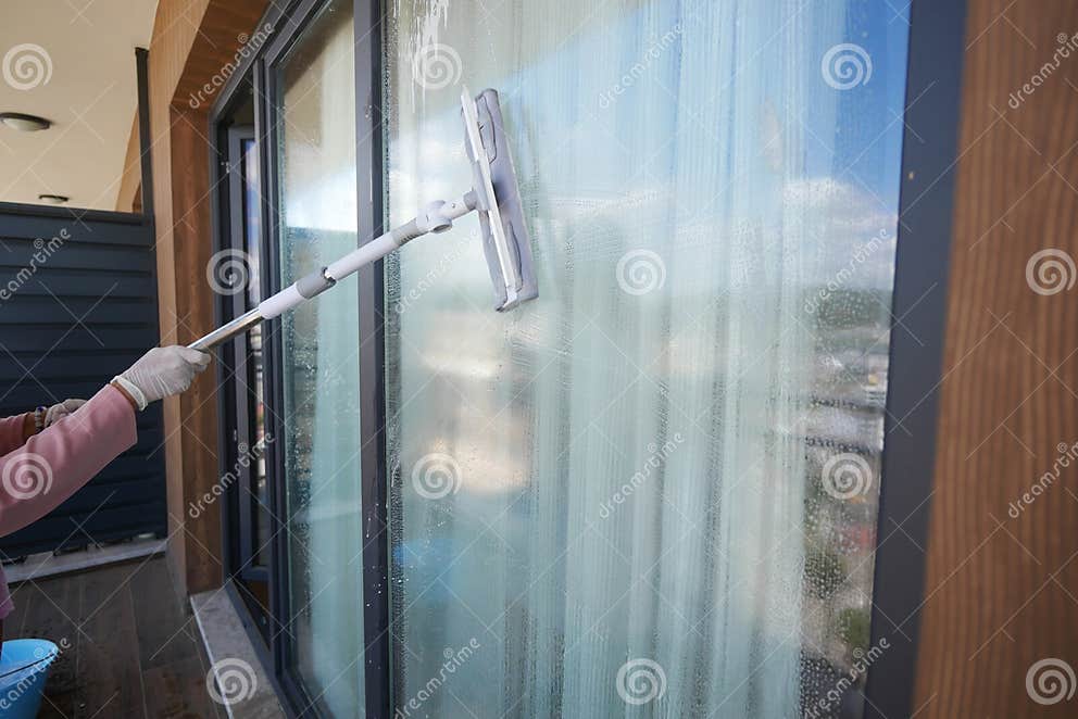 Rubber Squeegee Cleans a Soaped Window. Stock Image - Image of clear ...