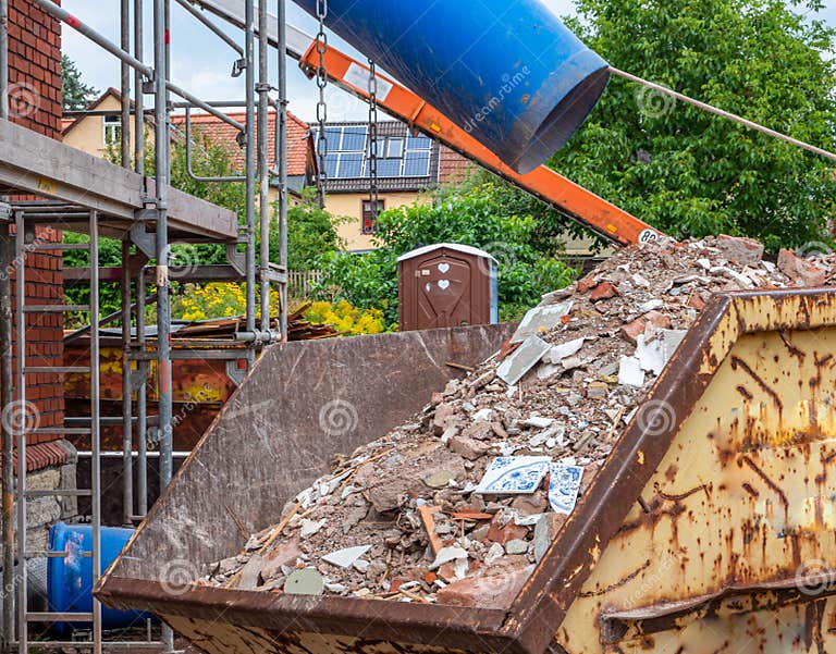 Rubble Chute with Debris and Container on a Construction Site Stock ...
