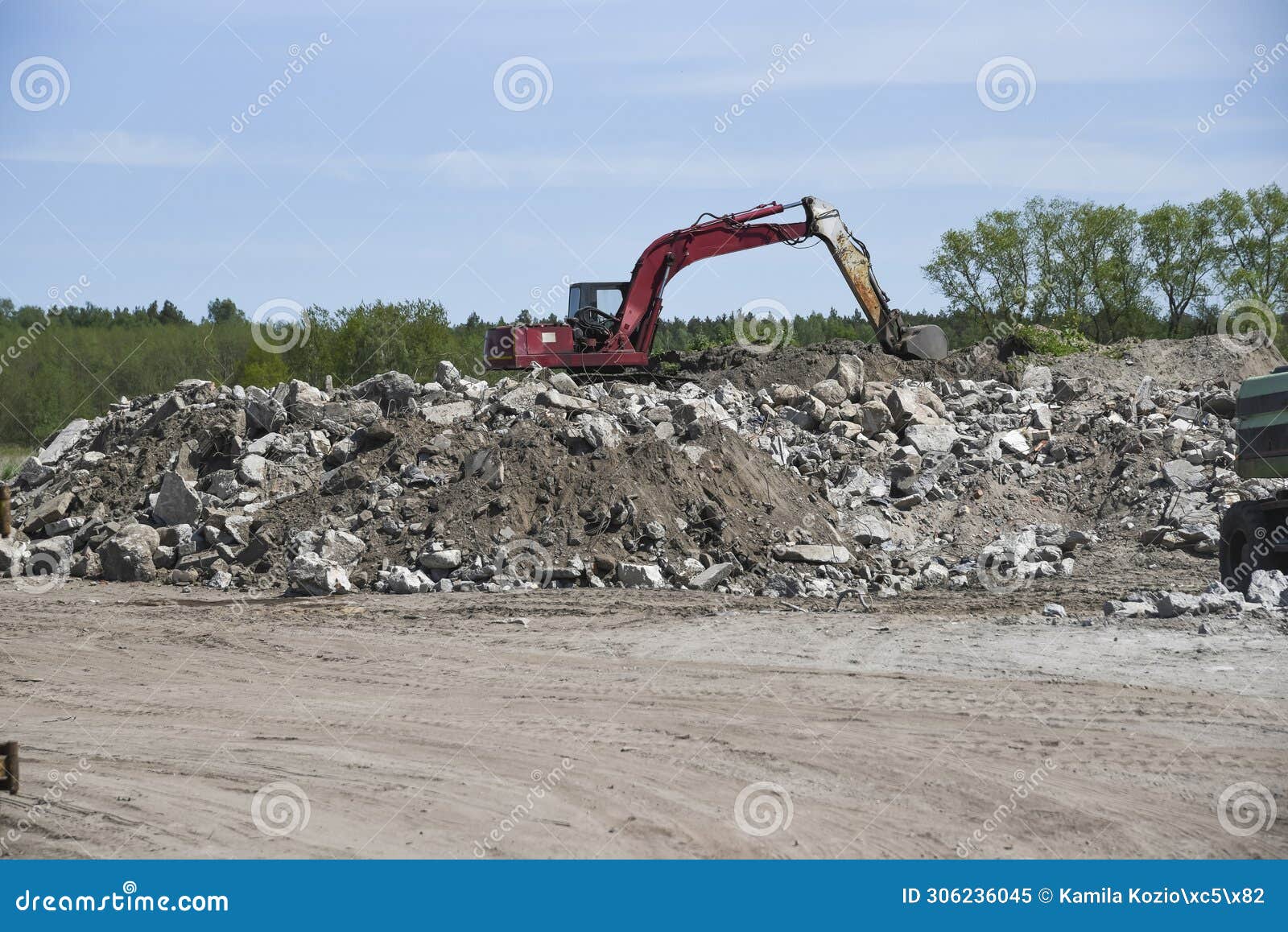 A Rubble Dump with an Excavator Cleaning Up the Mess Stock Image ...