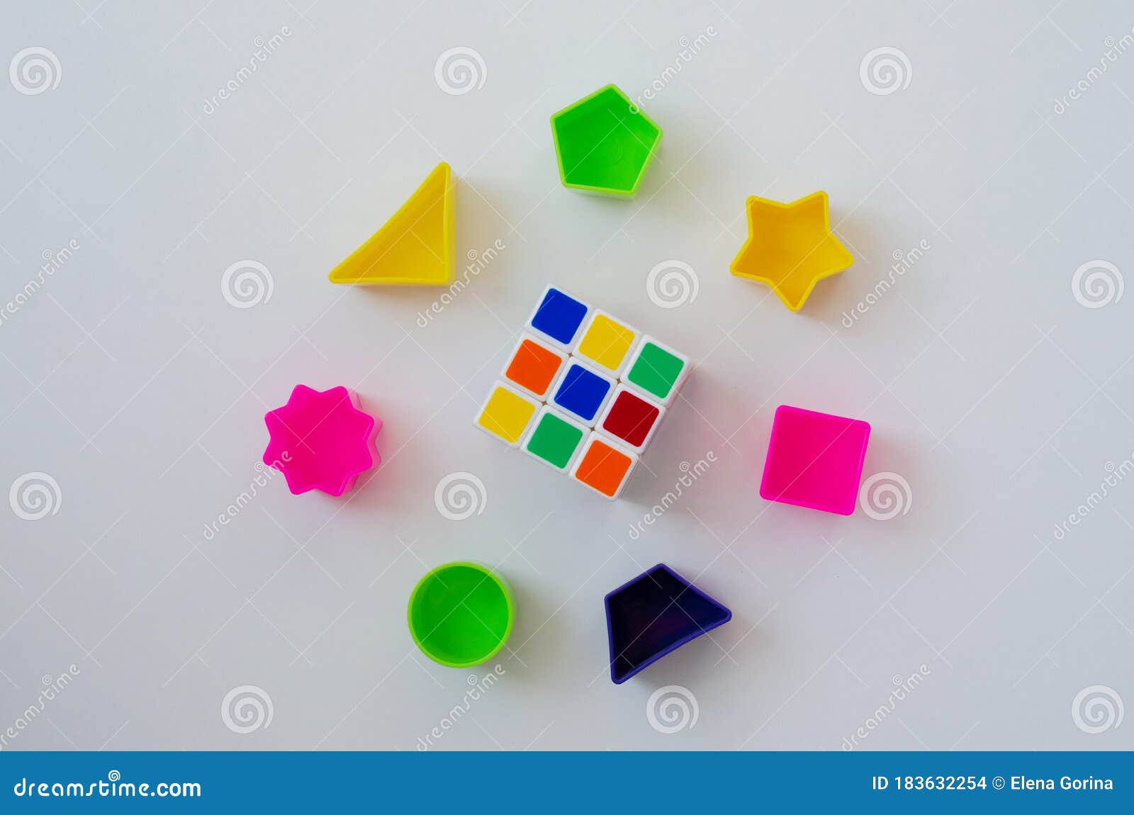 Rubik`s Cube and Different Game Color Pieces on a White Background ...