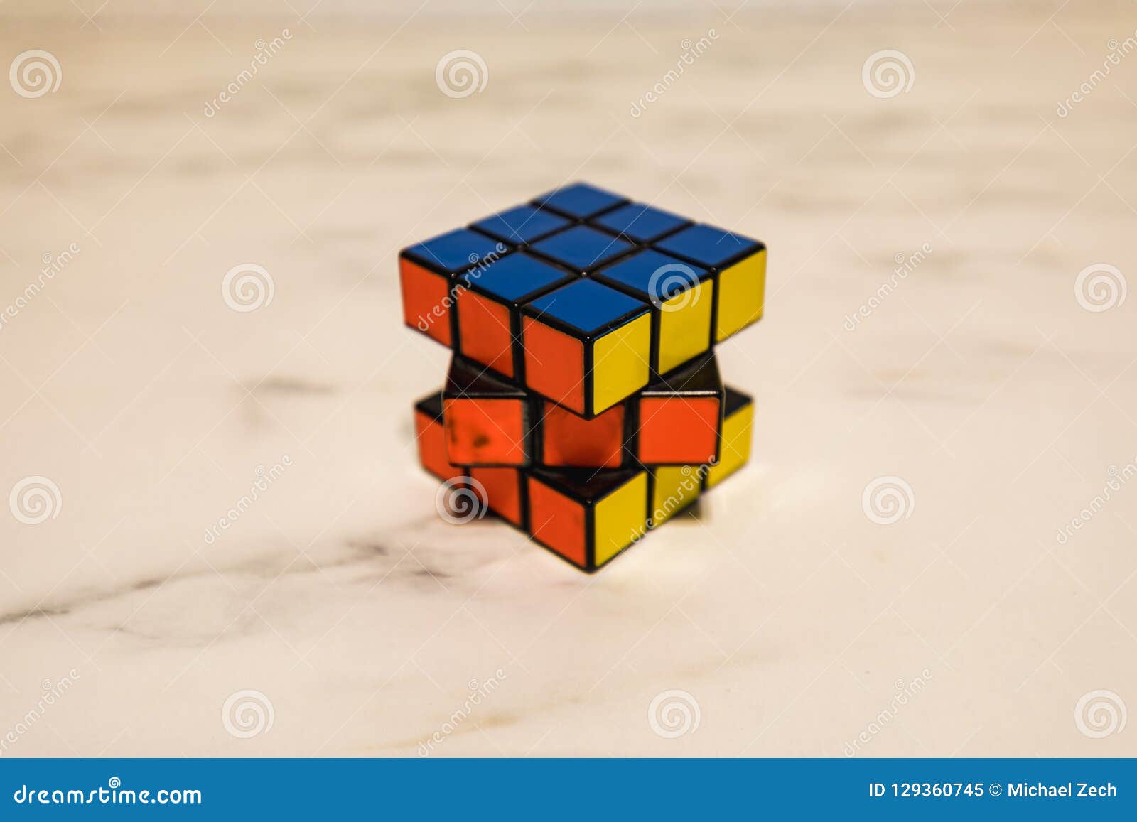 Rubik`s Cube on a Marble Plate, Showing Blue, Yellow and Orange ...