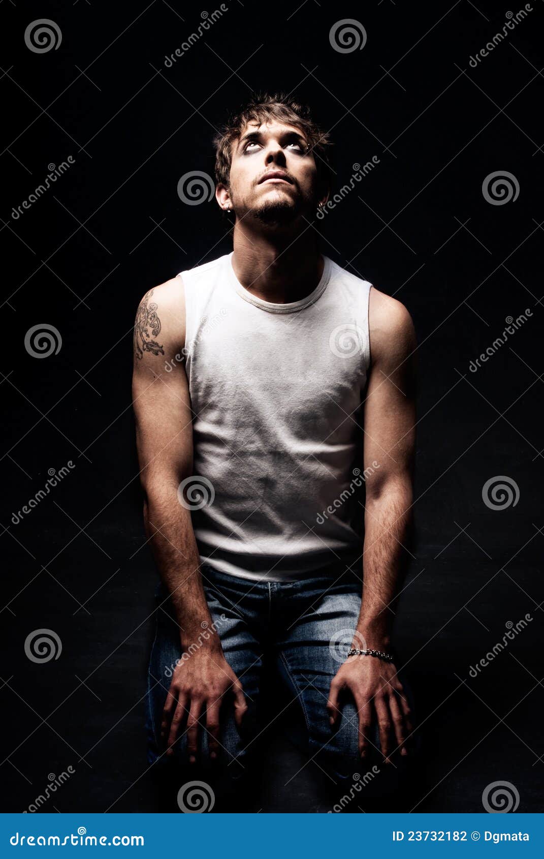 Rude Man on Knees Looking Up Tattoo Dark on Black Stock Photo - Image ...