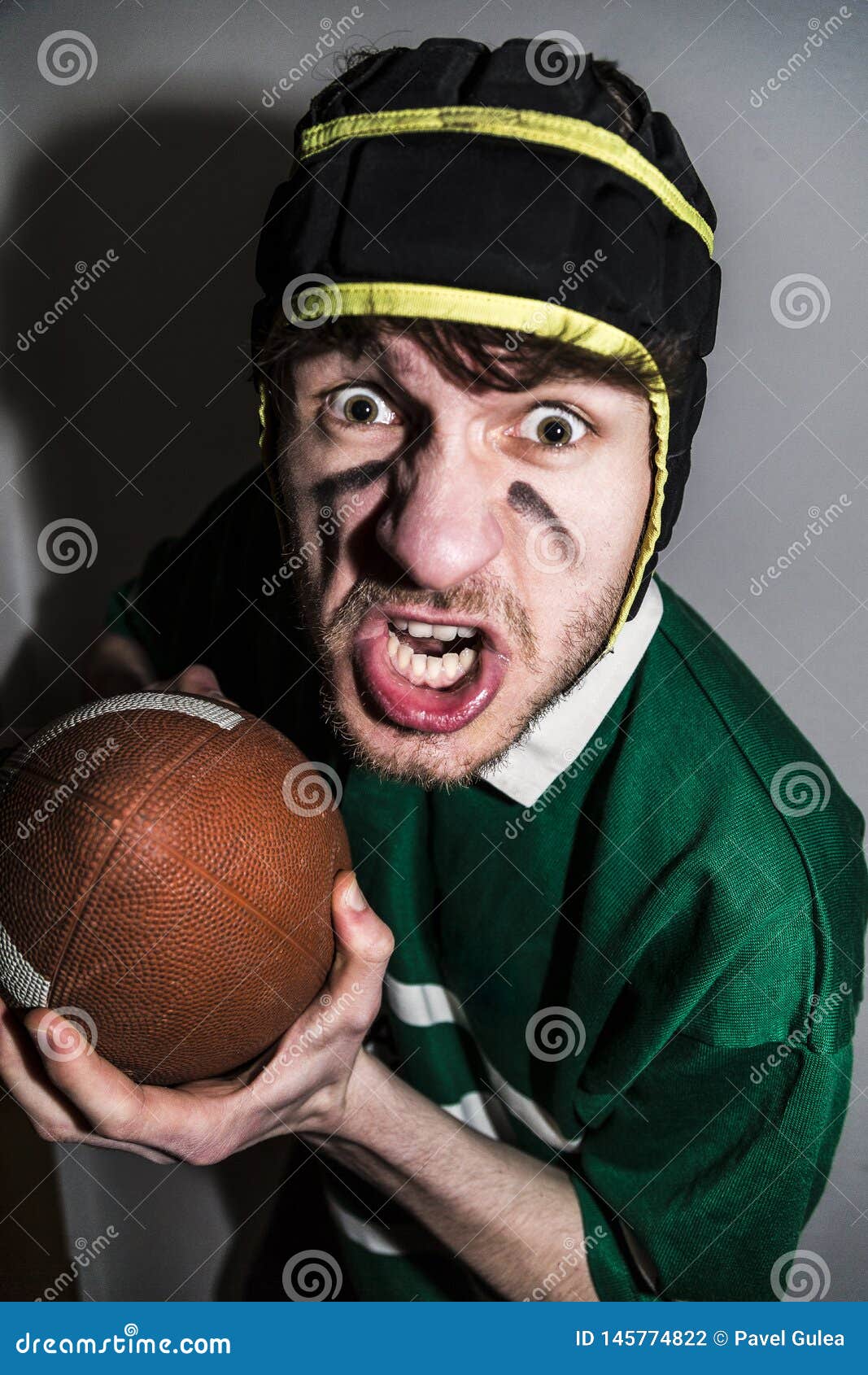 Rugby Player with Ball in Hands Making Wry Face Stock Photo - Image of ...