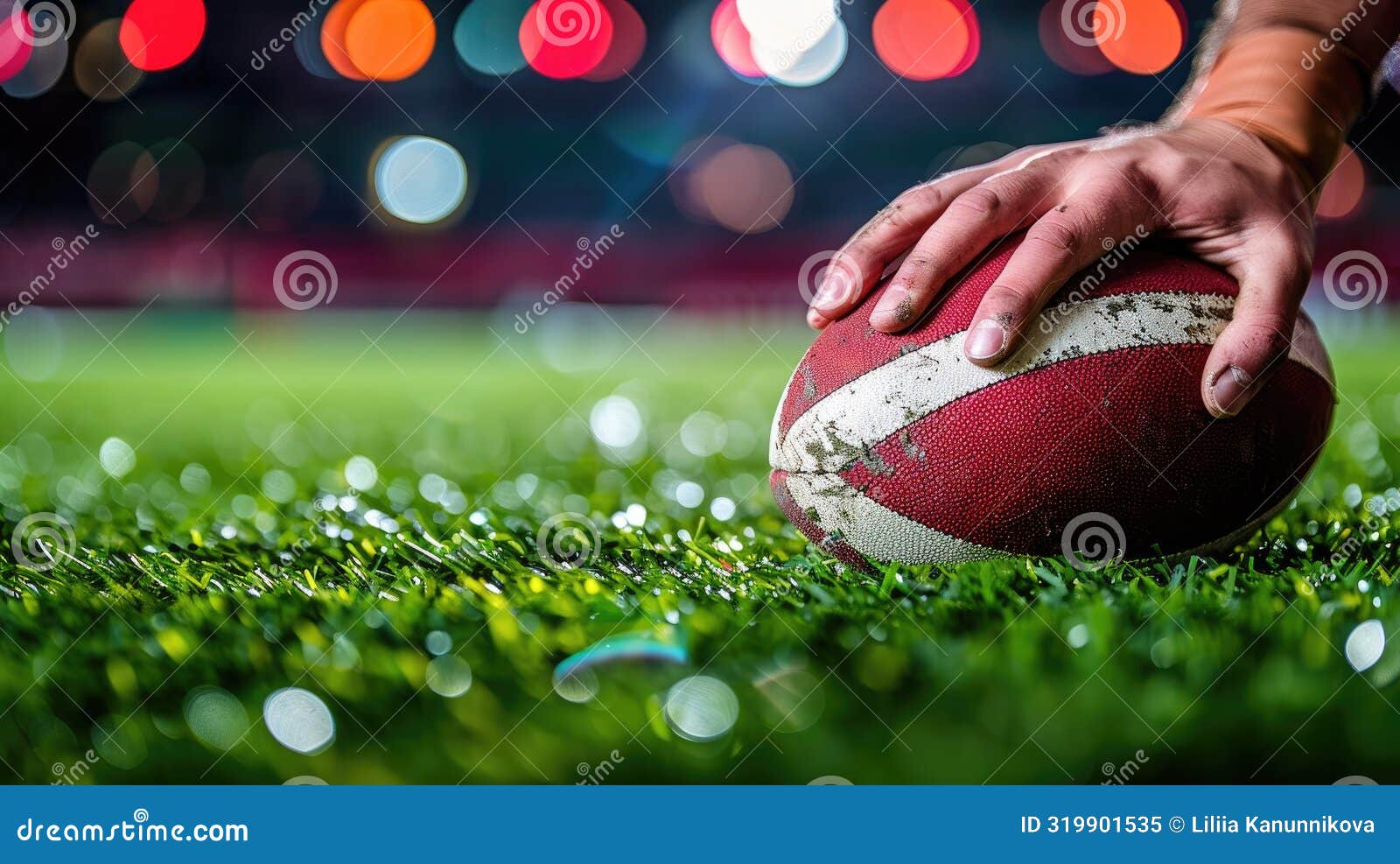 A Rugby Player S Hand Gripping a Rugby Ball on Green Grass Inside a ...
