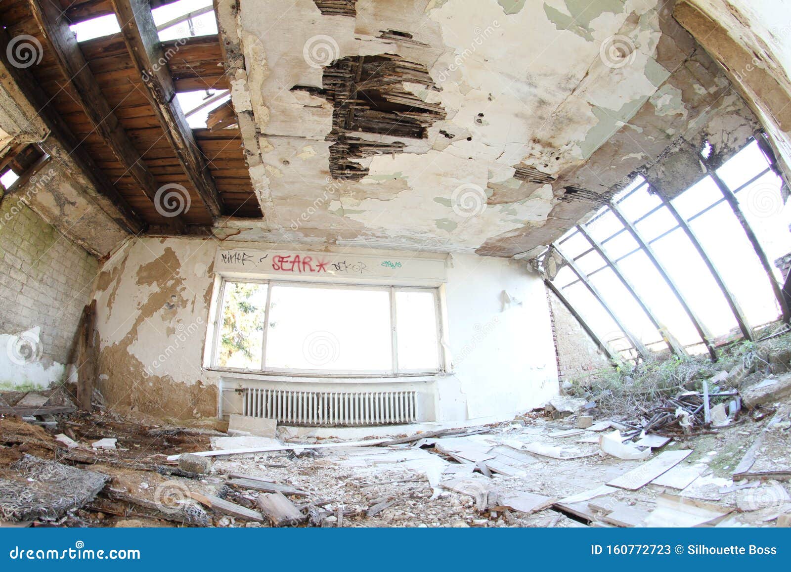 Ruined Room With Holes In Wall, Ceiling And Broken Windows In A Loft ...