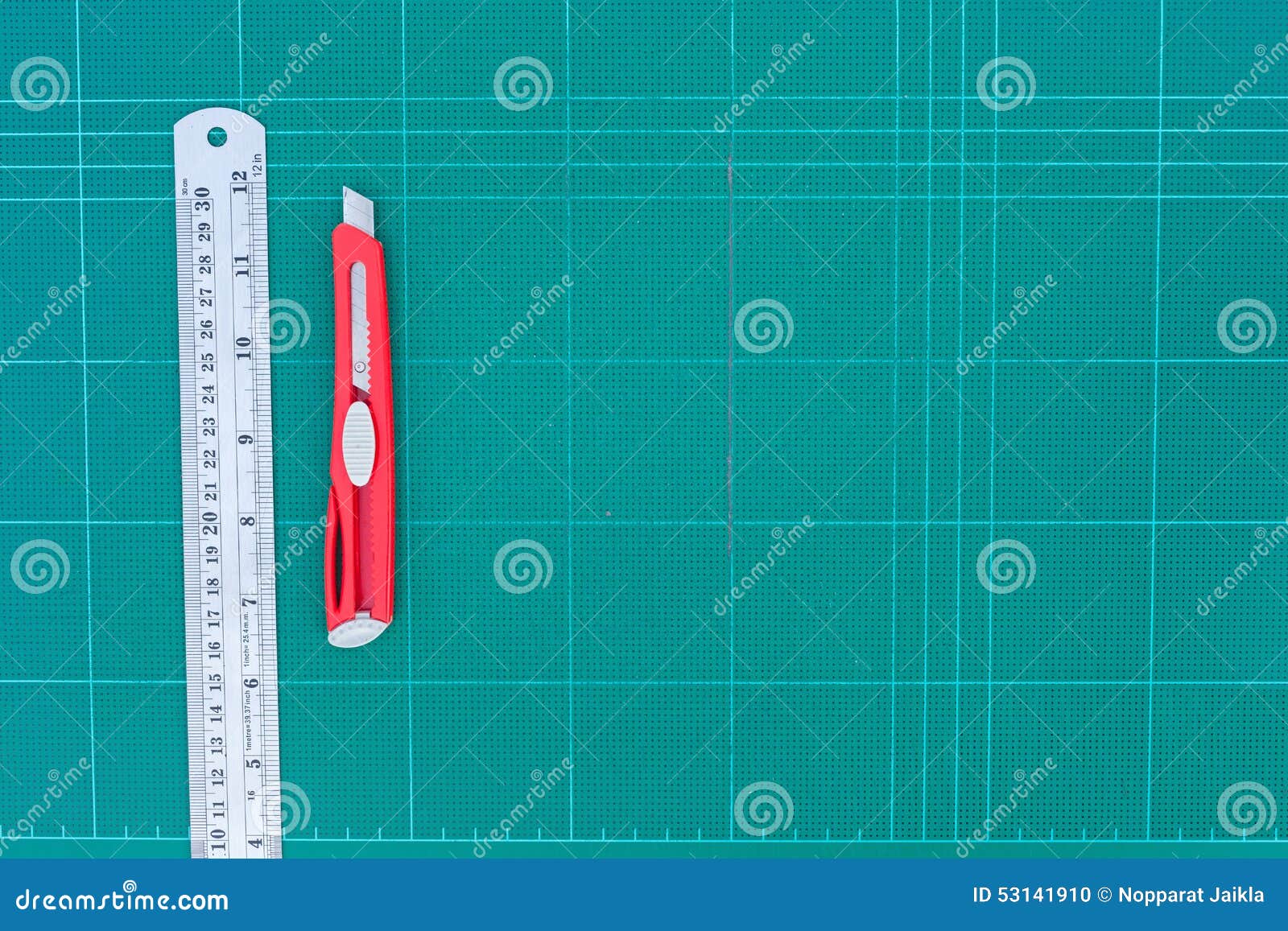 A Ruler and Cutter on Green Cutting Mat Stock Photo - Image of ...