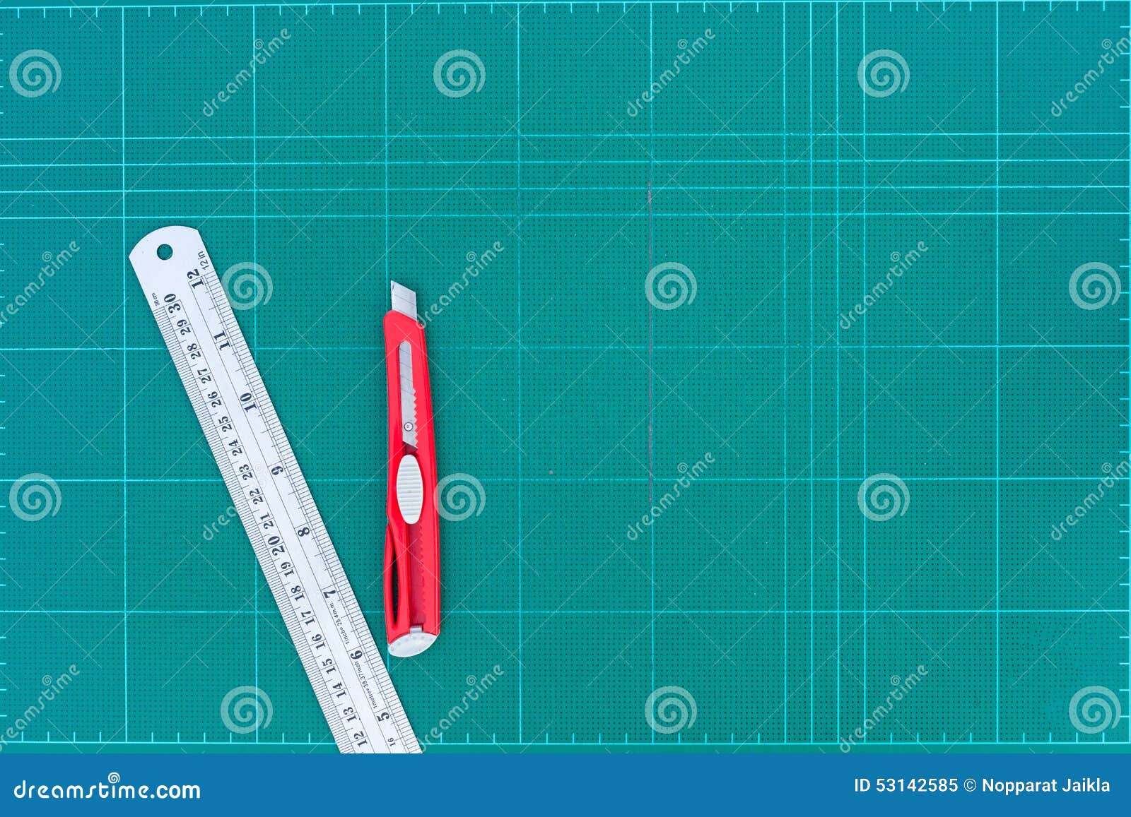 A Ruler and Cutter on Green Cutting Mat Stock Image - Image of ...