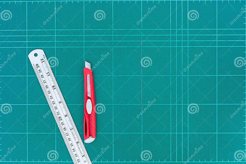 A Ruler and Cutter on Green Cutting Mat Stock Image - Image of ...