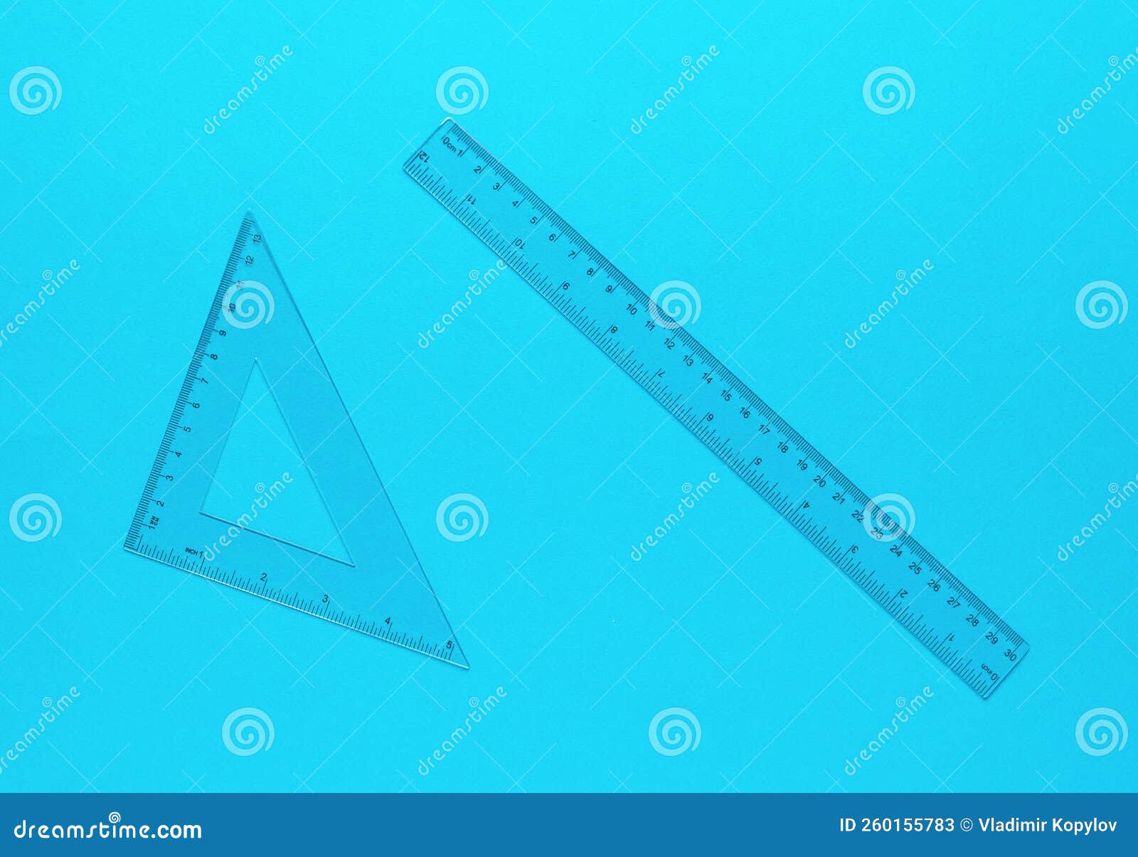 Ruler and Triangle Made of Transparent Plastic on a Blue Background ...