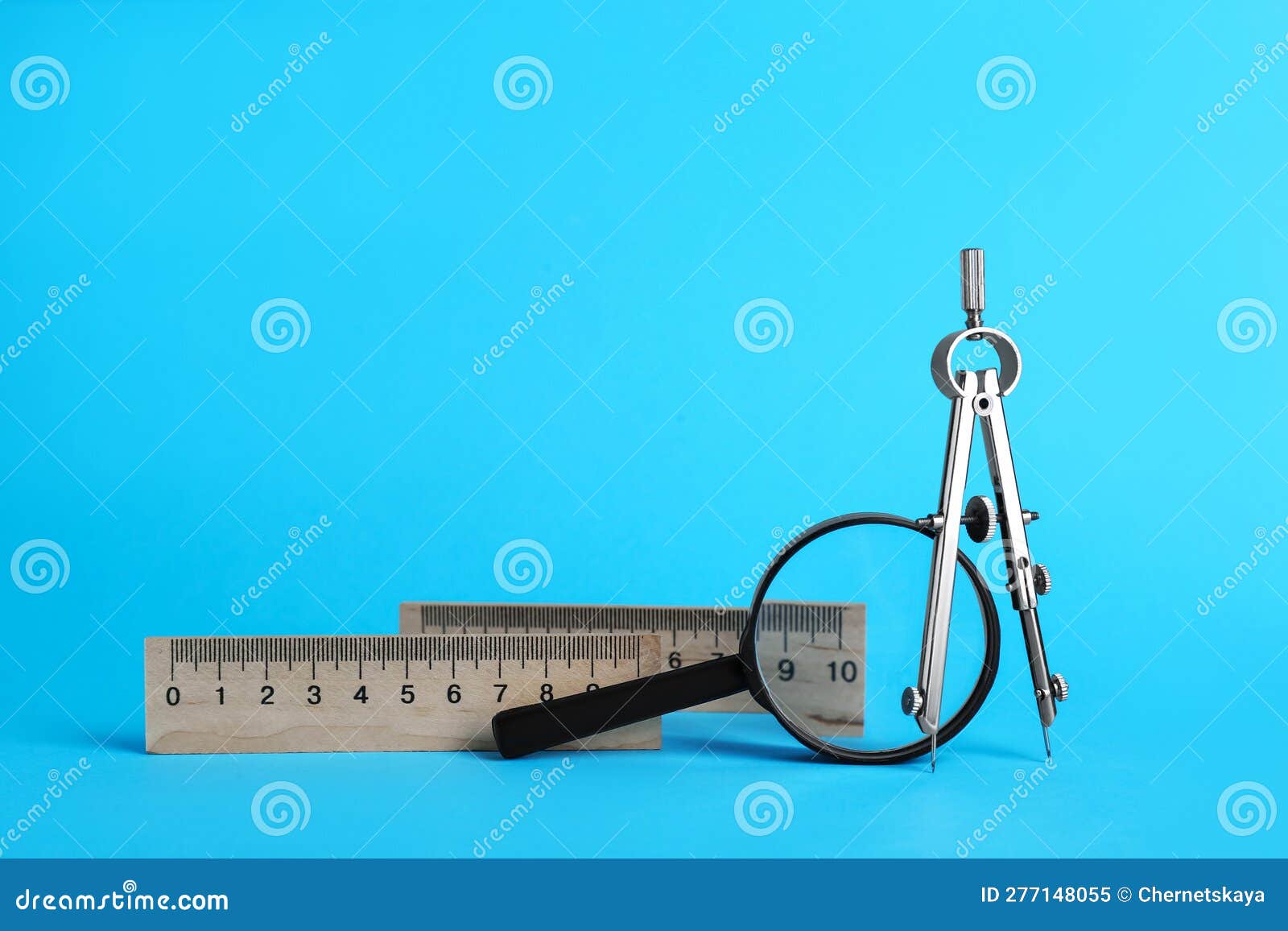 Rulers, Magnifying Glass and Compass on Light Blue Background Stock ...