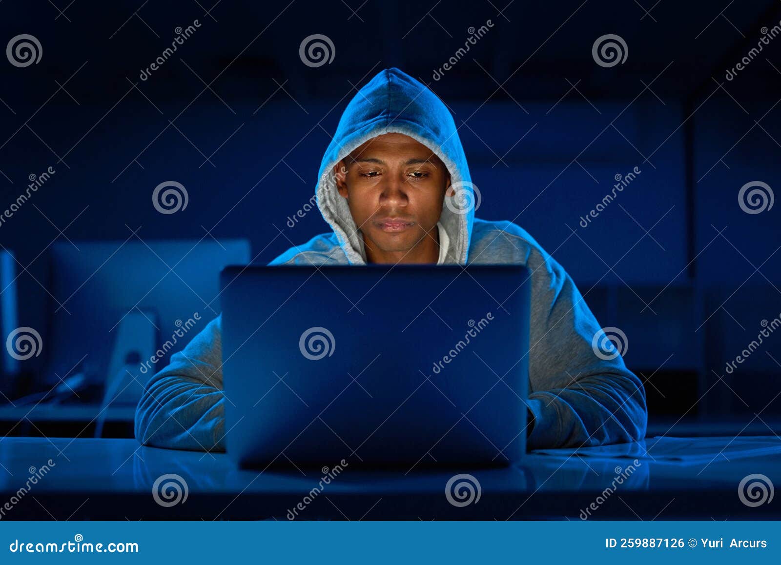 He Rules the Cyber World. a Young Male Hacker Using a Laptop in the ...