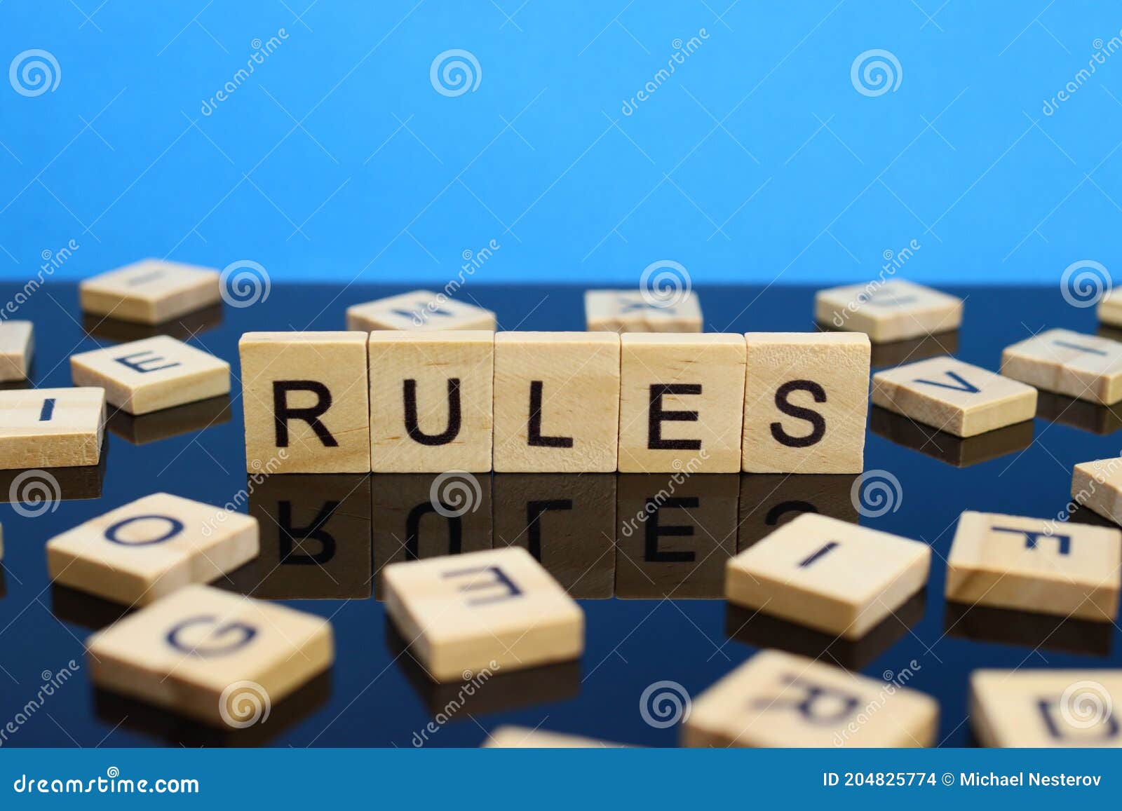 Rules Word Made of Wooden Letters on a Mirror Surface on a Blue ...