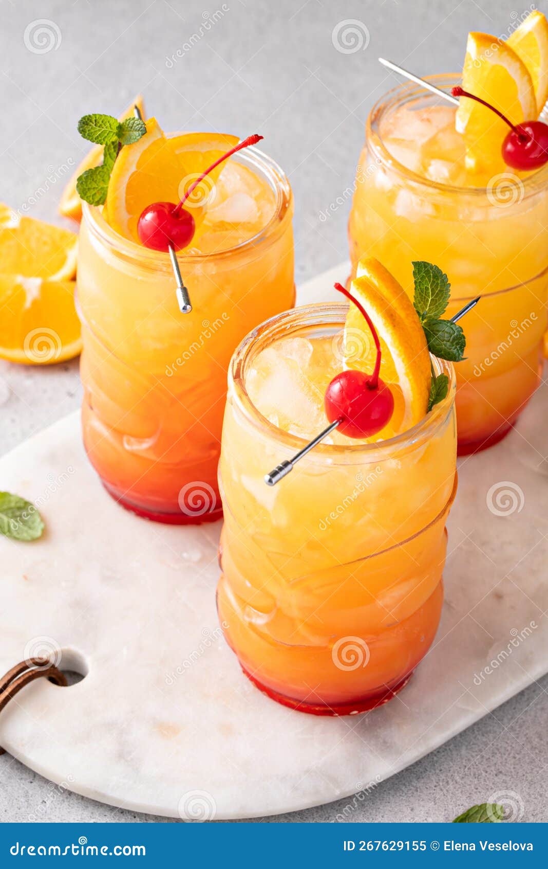 Rum Punch in Tiki Glasses with Orange Slices and a Cherry Stock Image ...