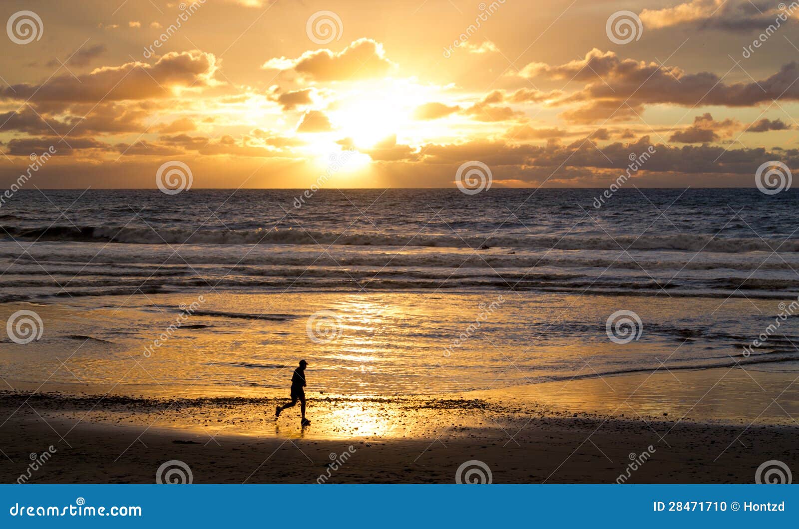 Runner on beach at sunset stock photo. Image of water - 28471710