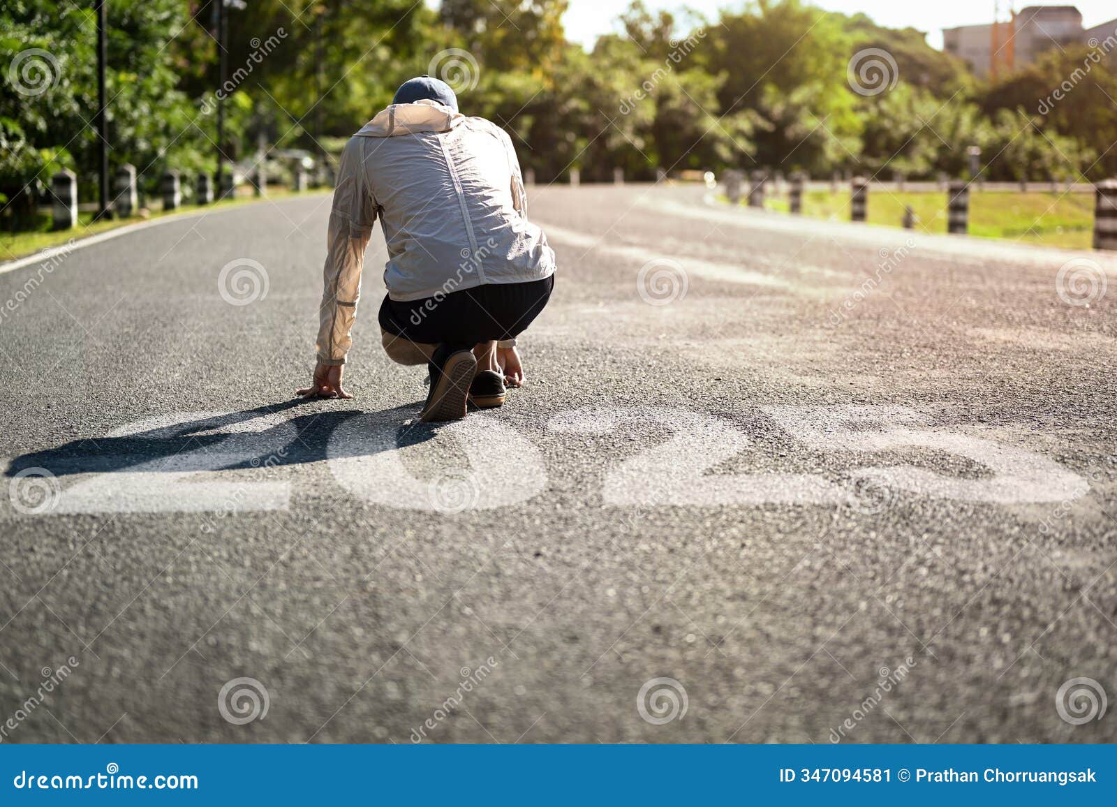 Runner Crouching in a Starting Position on Road with the Numbers 2025 ...