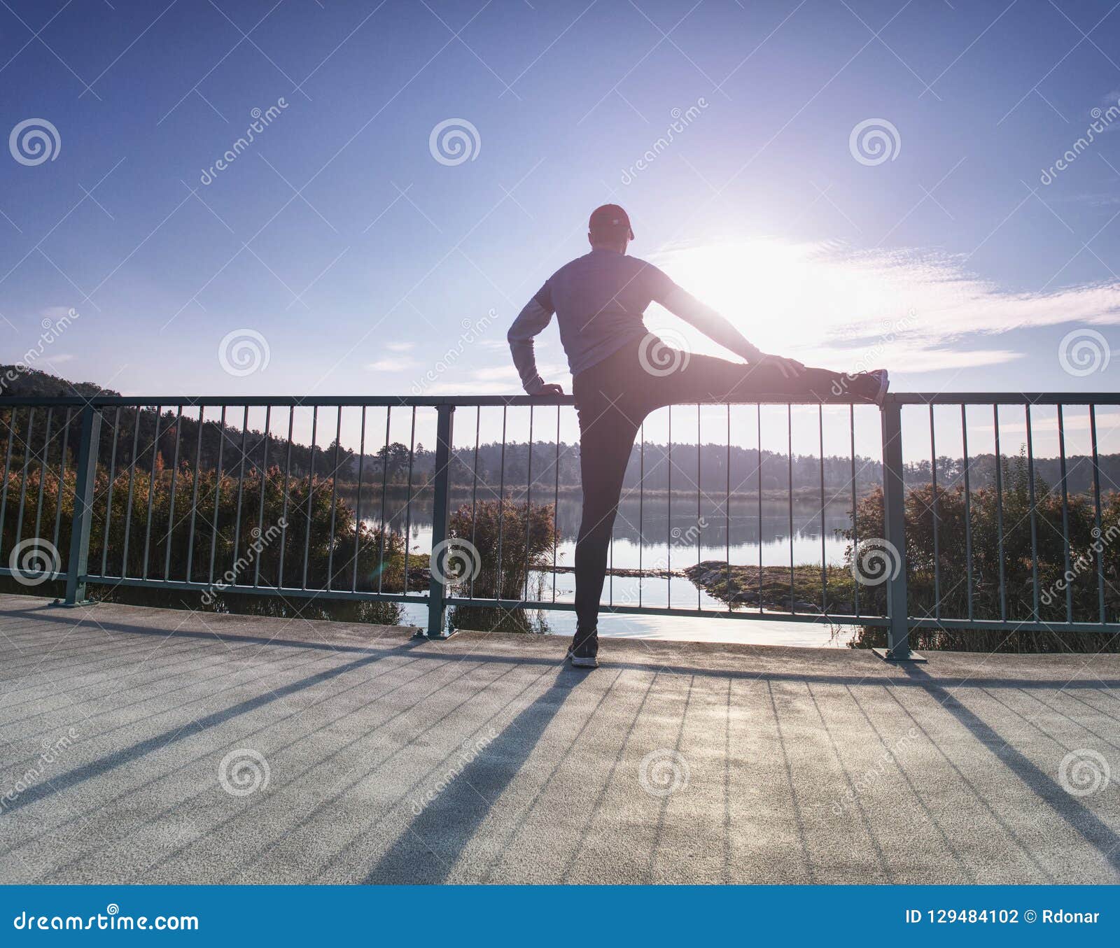Runner Doing Stretching Exercise on Bridge. an Active Wiry Man Stock ...