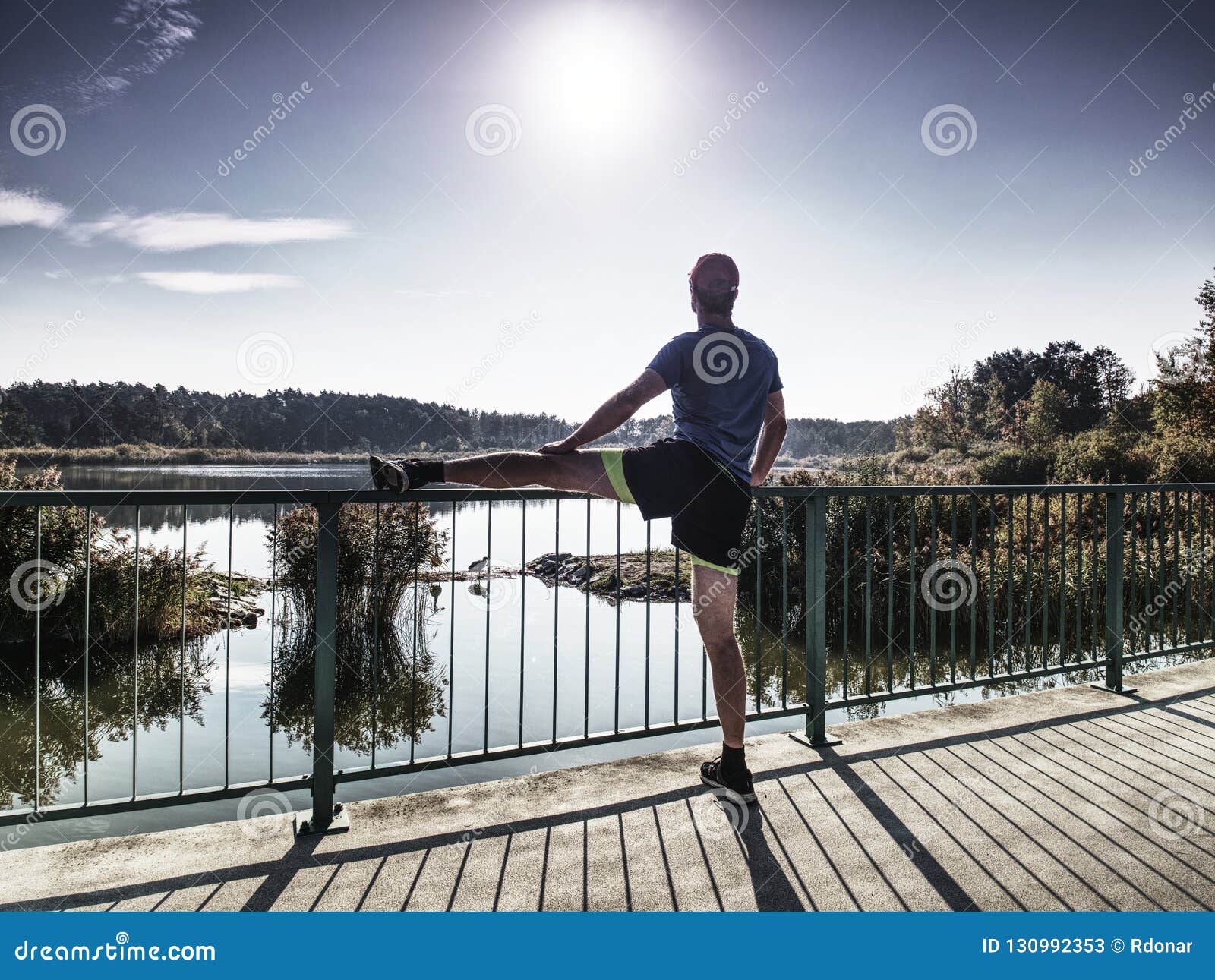 Runner Doing Stretching Exercise on Bridge. an Active Wiry Man Stock ...