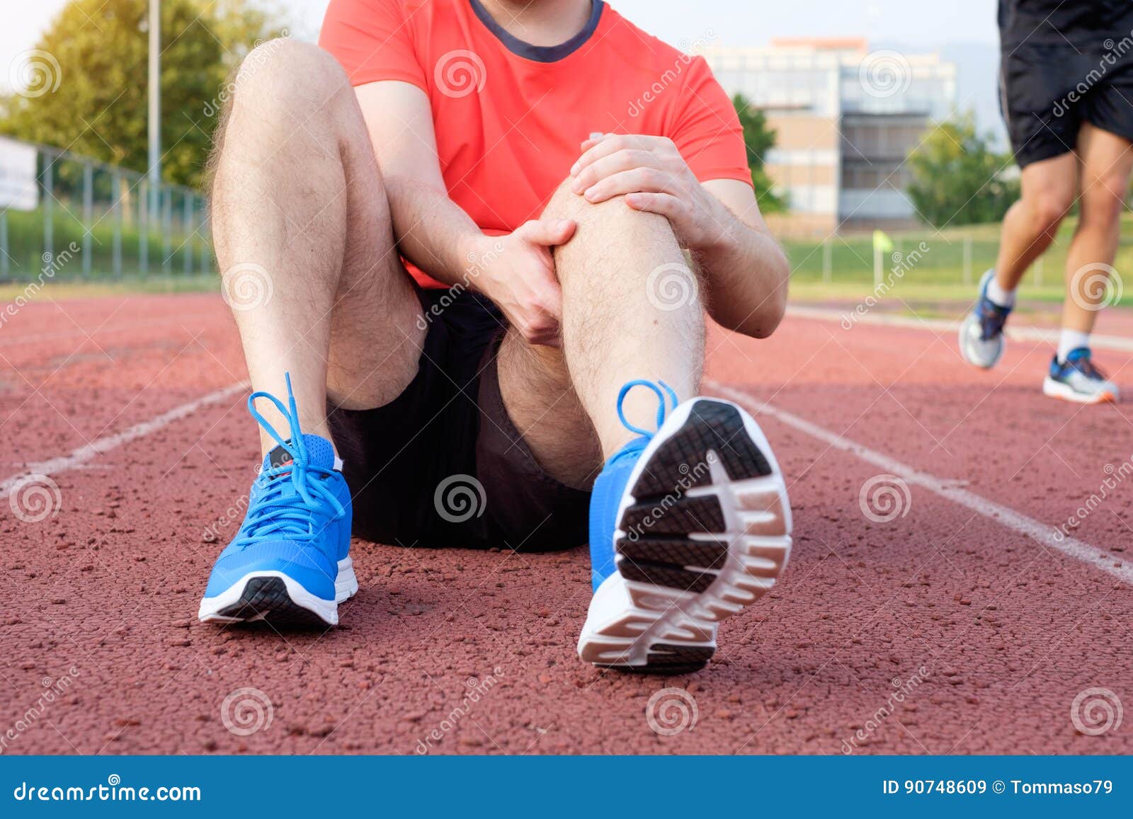 Runner with Injured Knee on Track Stock Image - Image of injury, knee ...