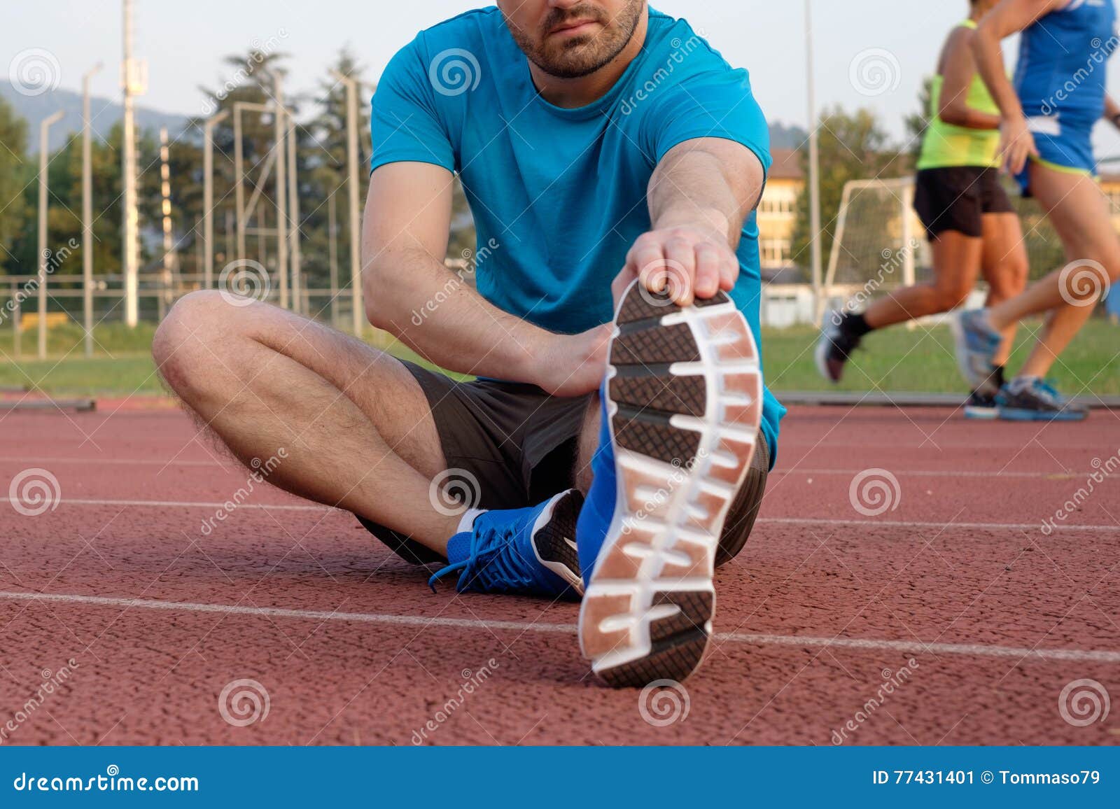Runner making stretching stock image. Image of clothes - 77431401