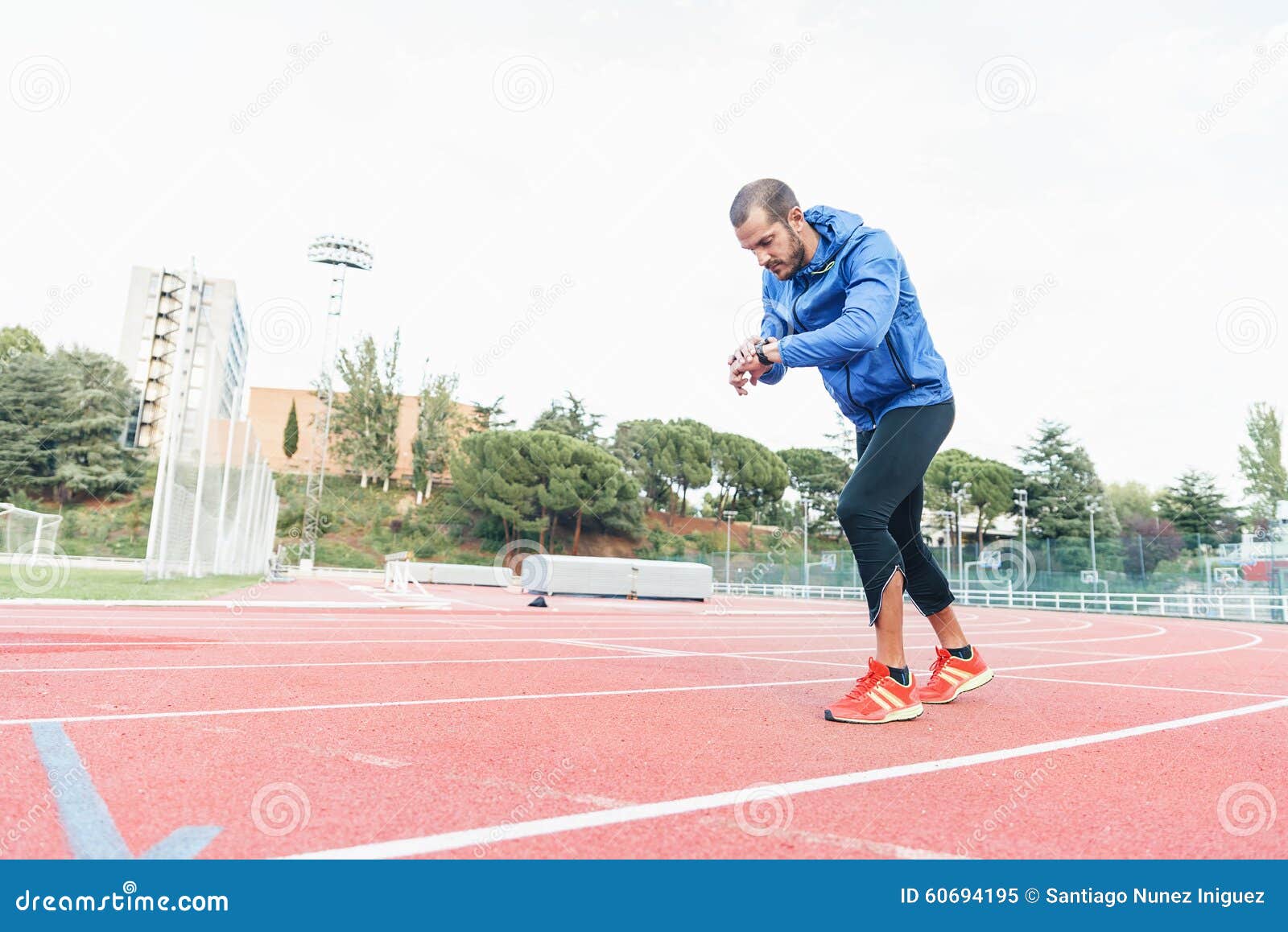 Runner Ready To Run is Looking at His Watch. Stock Image - Image of ...