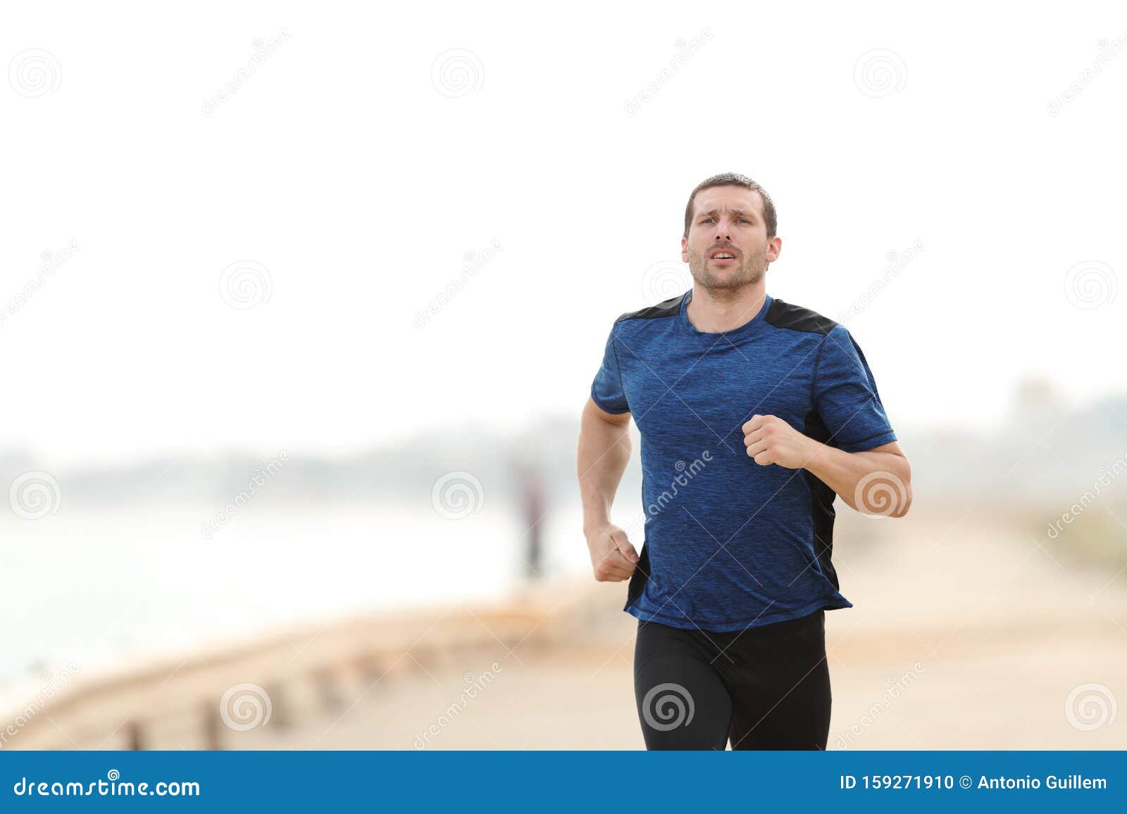 Runner is Running Towards Camera Training on the Beach Stock Photo ...