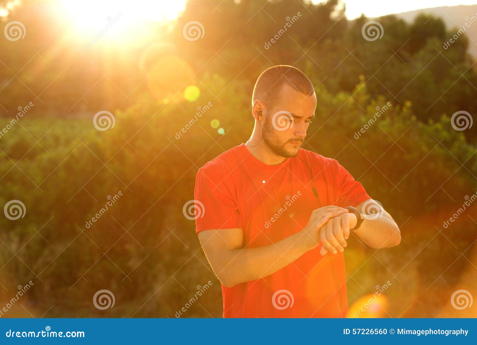Runner Standing Outside Looking at Watch Stock Photo - Image of looking ...