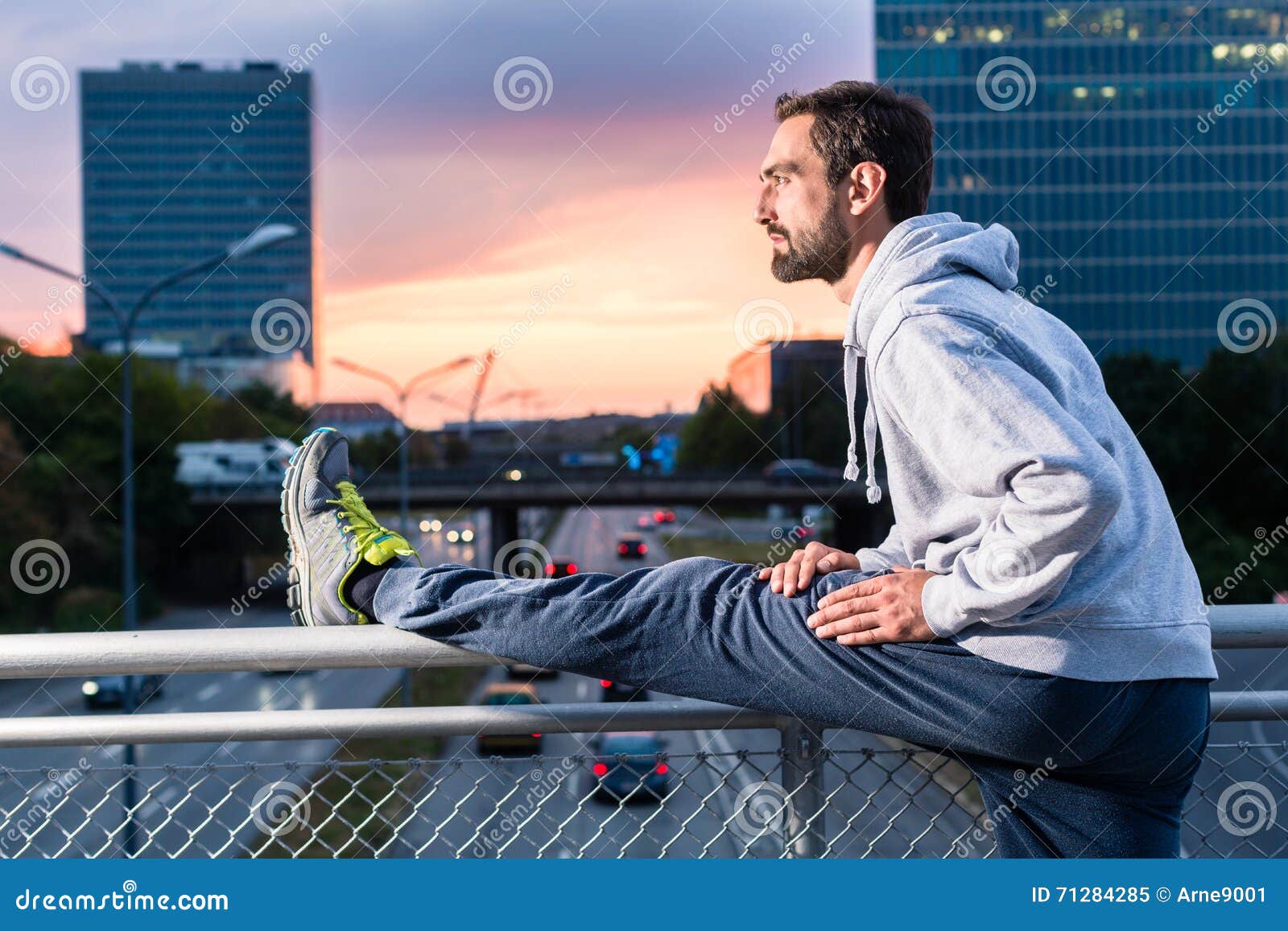Runner Stretching in Front of Office Building at Sunset Stock Image ...