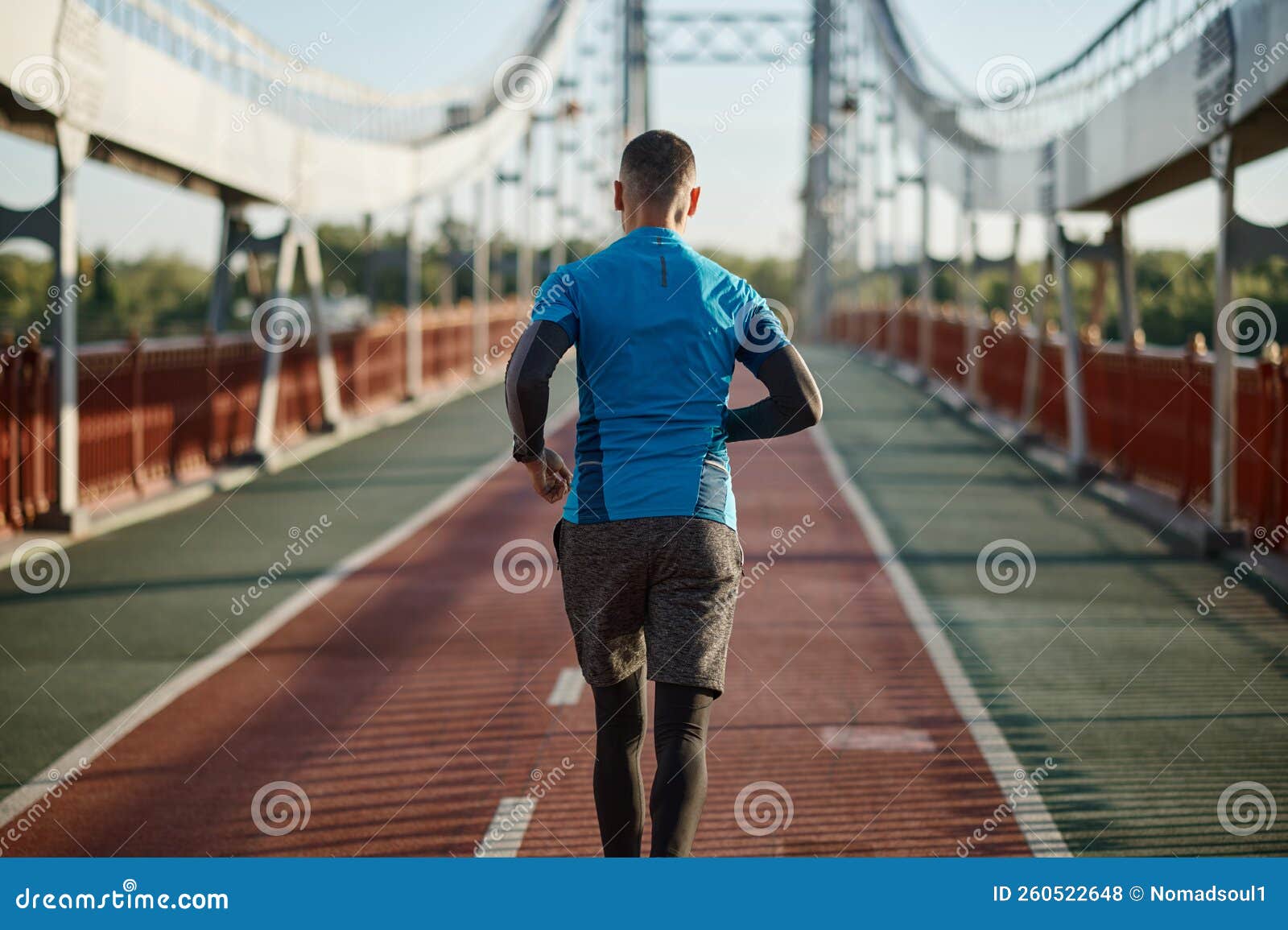 Runner Training Jogging on Road Outside in Rear View Stock Photo ...