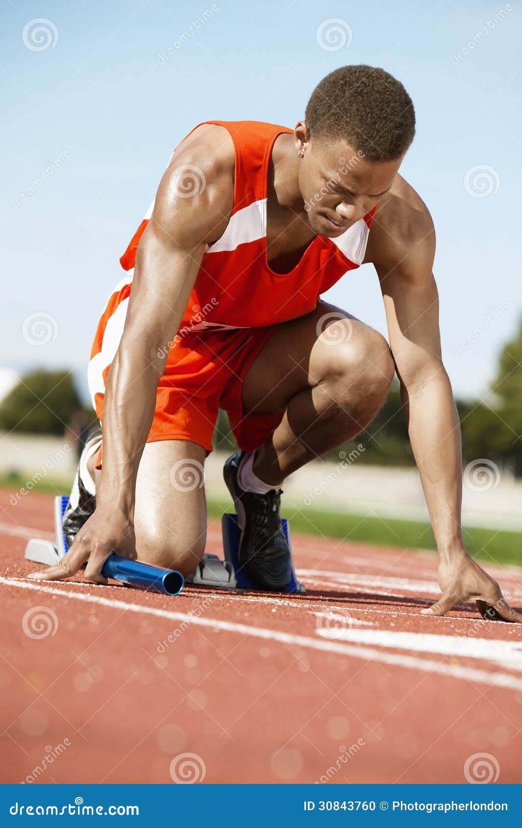 Runner Waiting with Baton at Starting Block Stock Photo - Image of palm ...