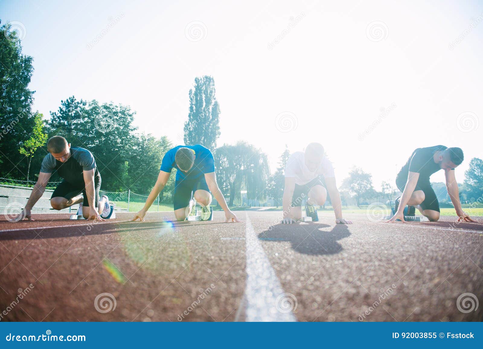 Runners Preparing for Race at Starting Blocks Stock Image - Image of ...