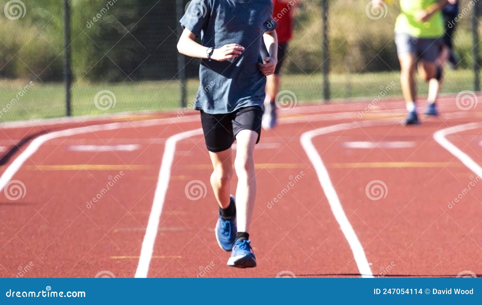 Runners running on a track stock photo. Image of kids - 247054114