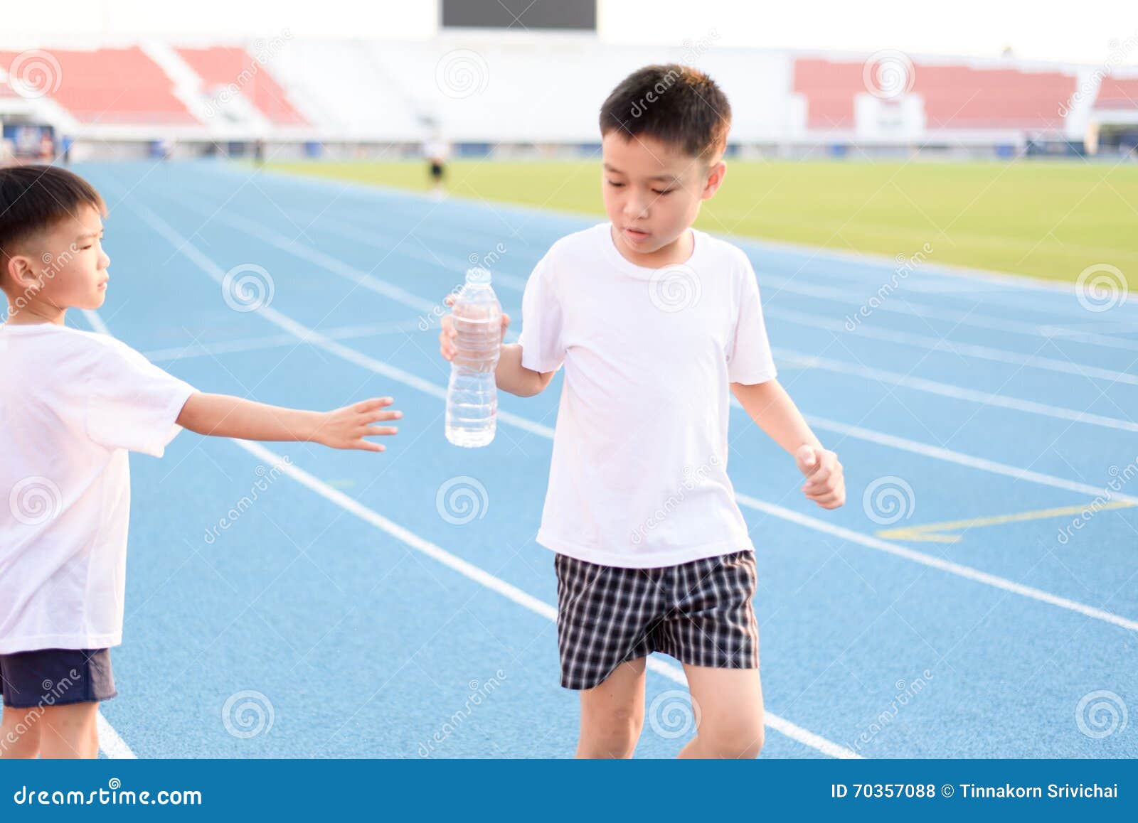 Running boy take water stock photo. Image of marathon - 70357088