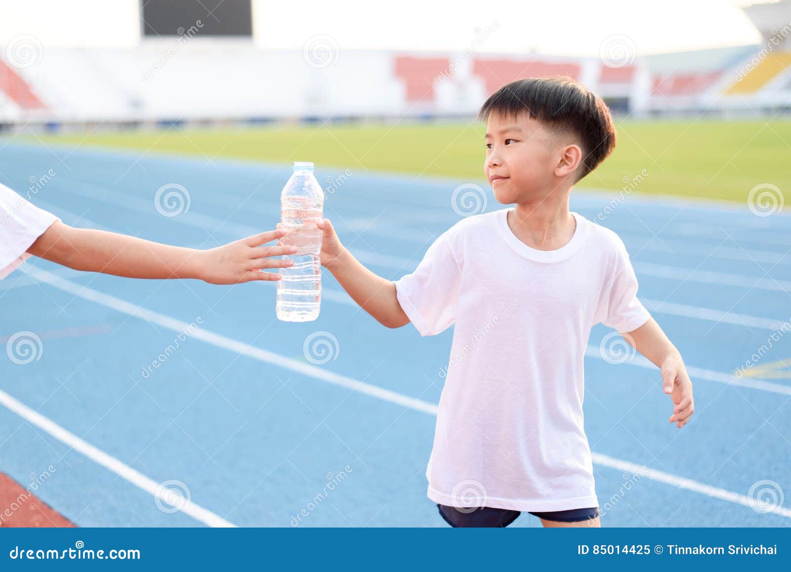Running boy take water stock image. Image of help, active - 85014425