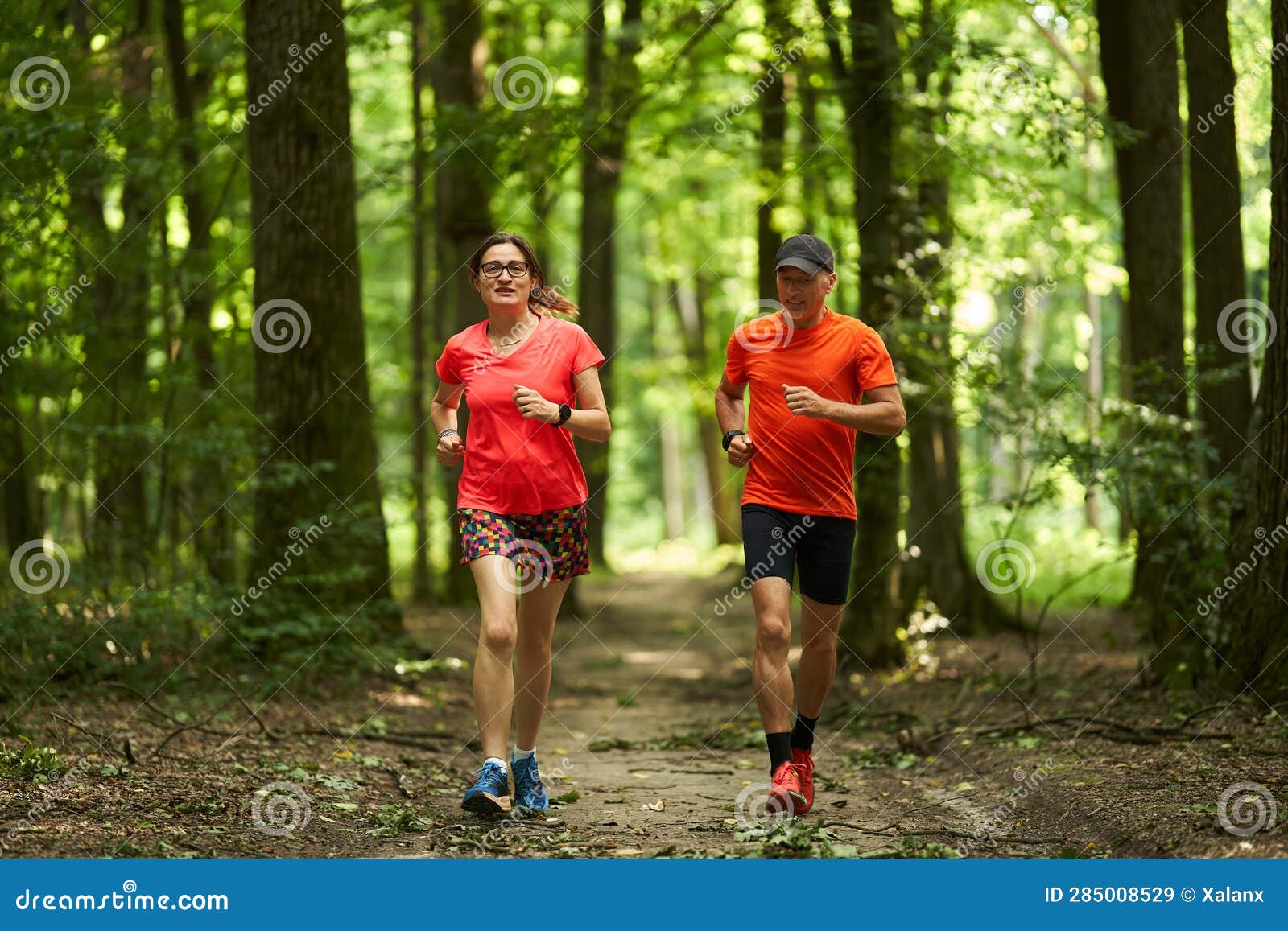 Running Couple in the Forest Stock Image - Image of people, road: 285008529
