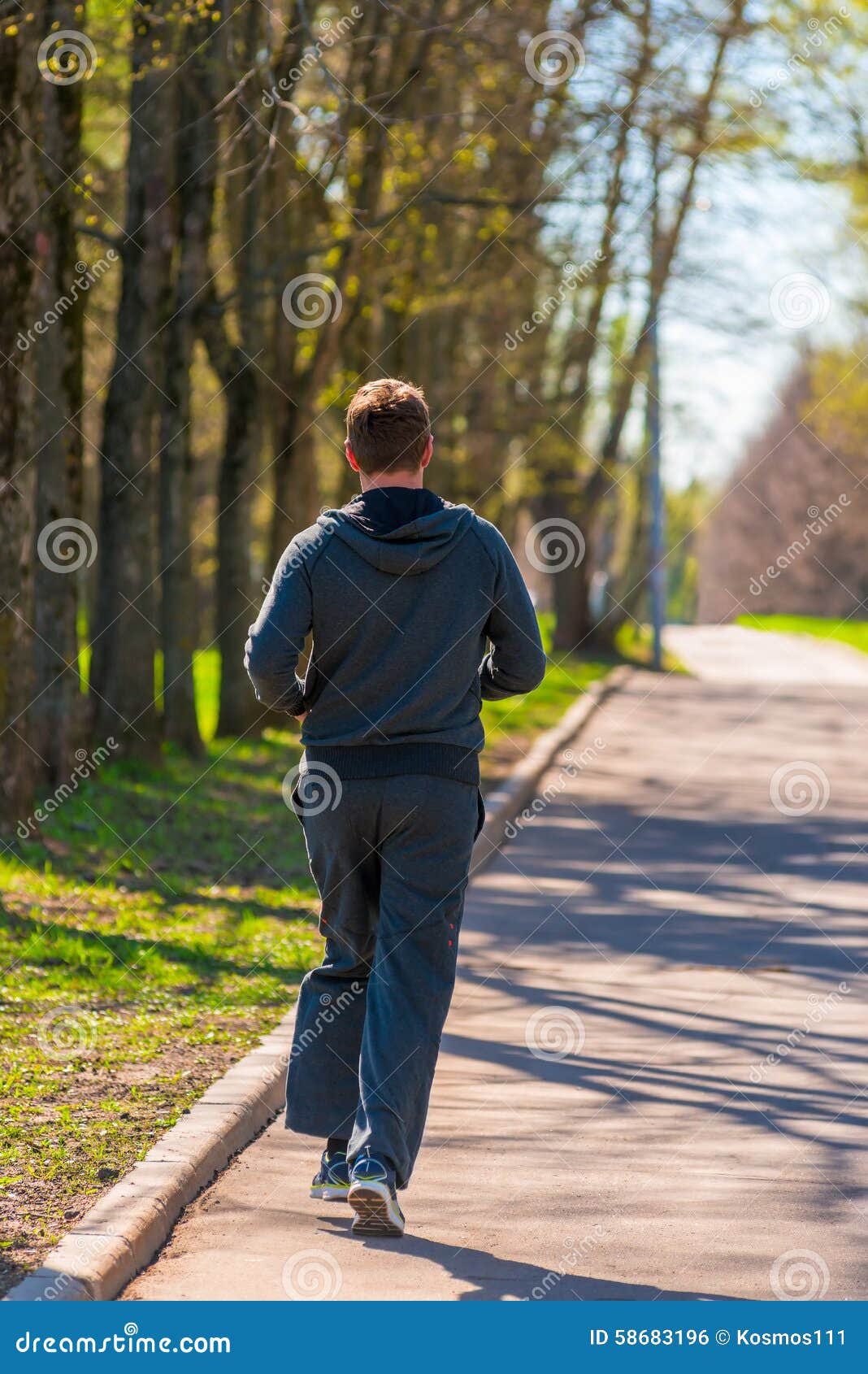 Running Man in the Park View from Back Stock Photo - Image of motion ...