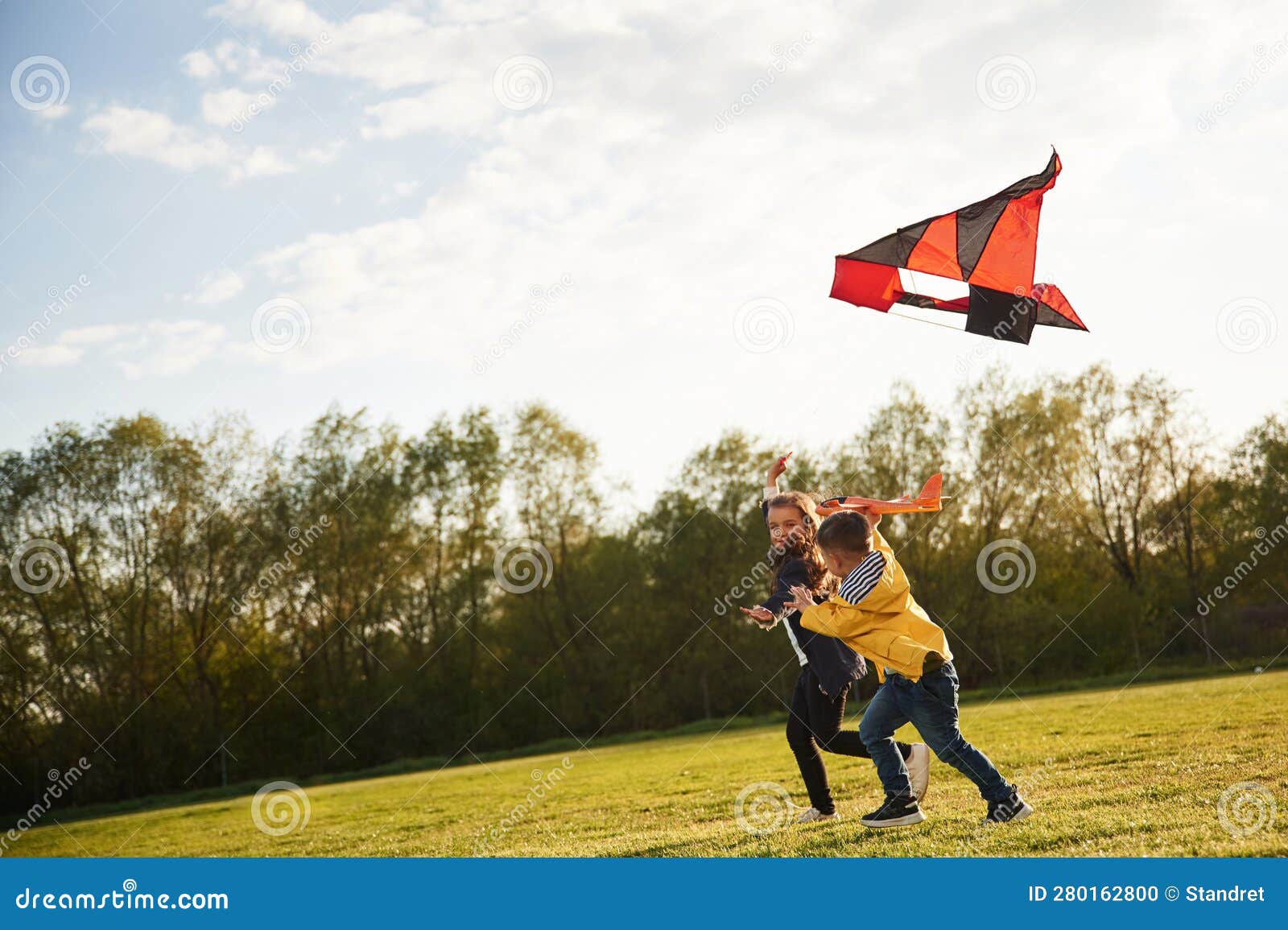 Two Kids are Playing with Kite on the Summer Field Stock Photo - Image ...