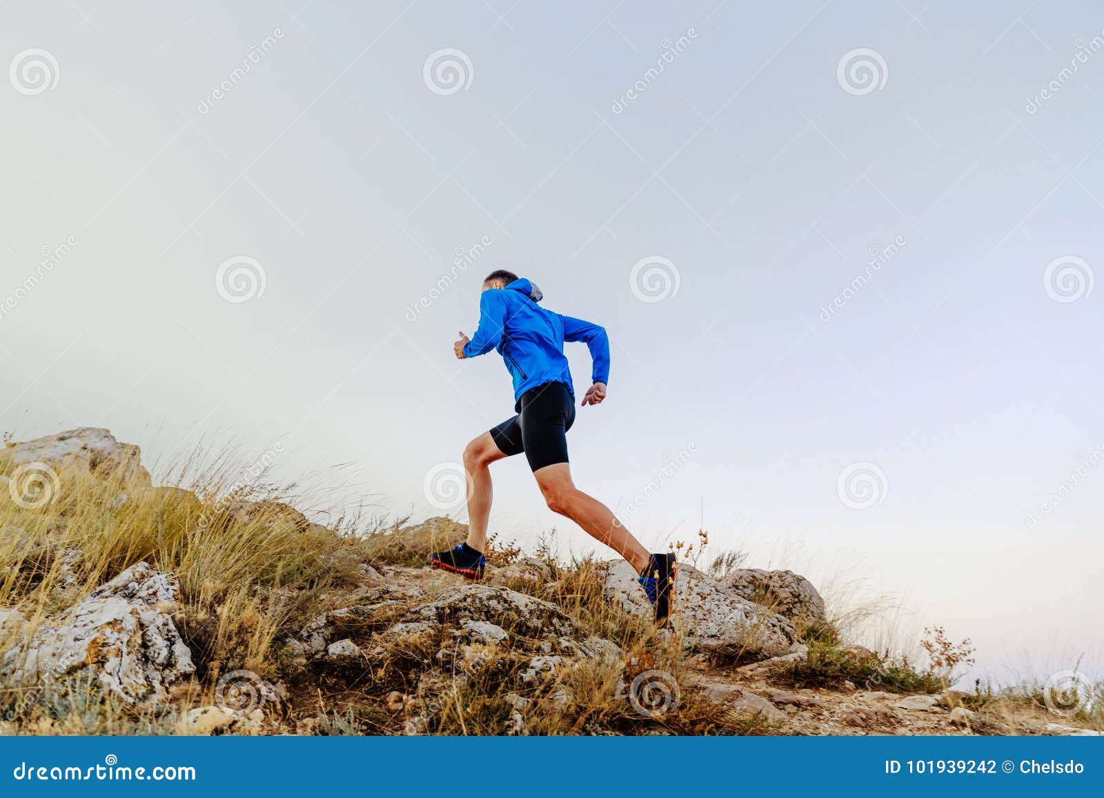 Running Uphill on Stones Male Athlete Stock Photo - Image of race, blue ...