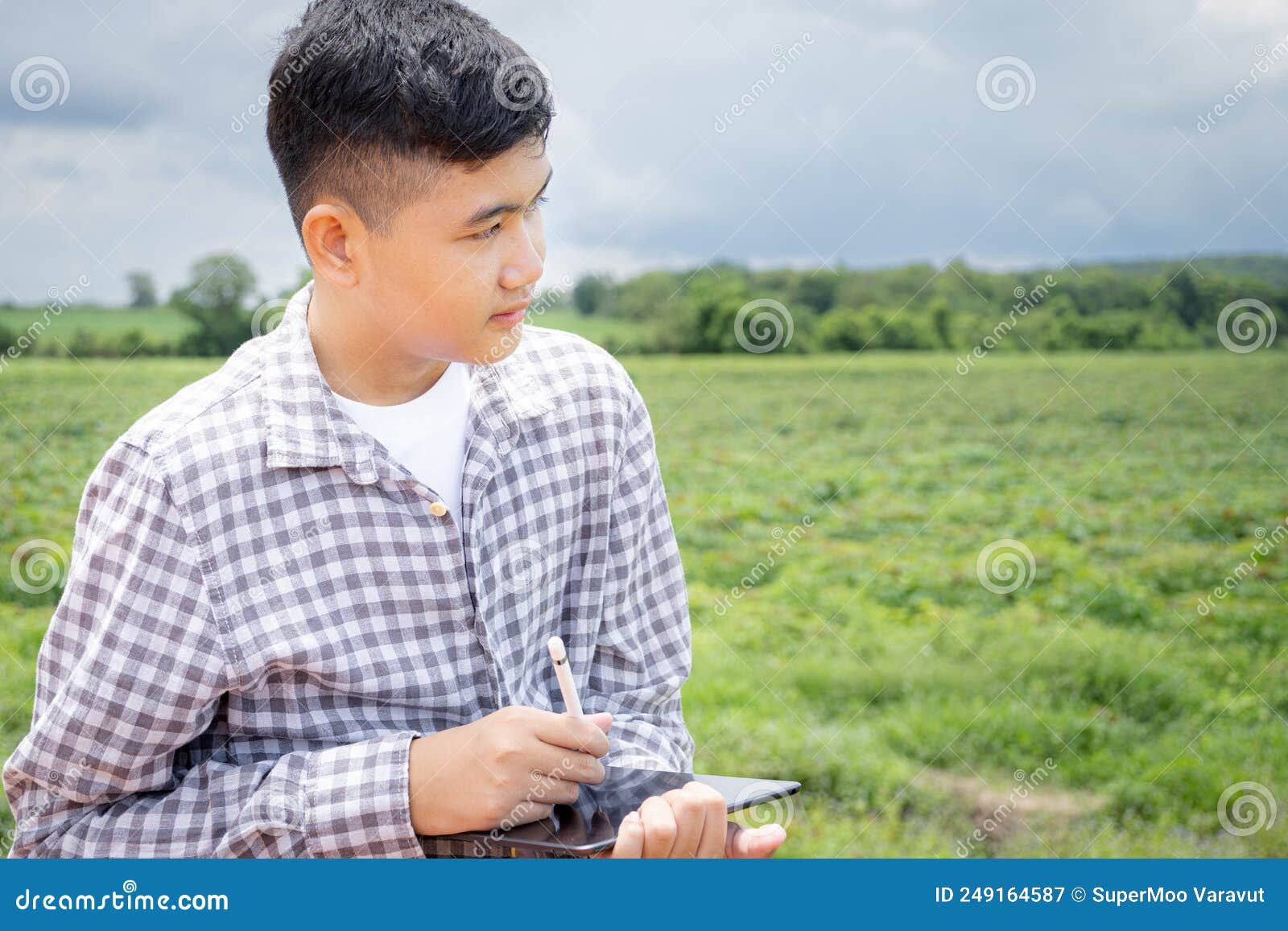 Rural Boy Using Tablet Keeping Records of Working in Agricultural ...