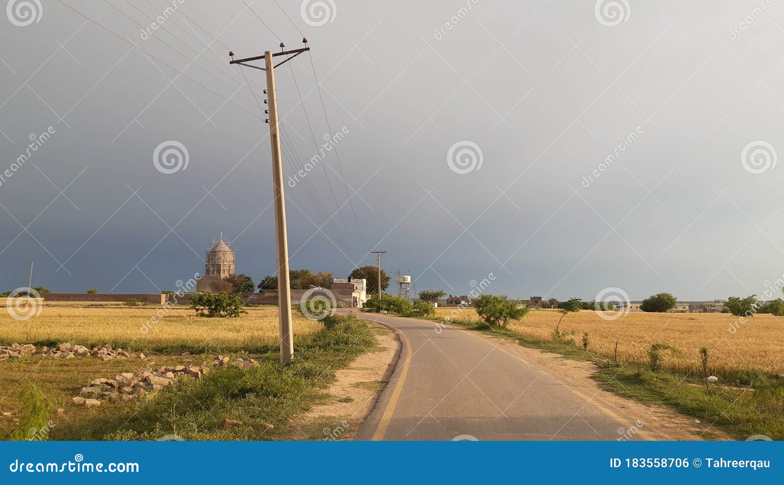 A Rural Road Crossing through Wheat Fields Stock Photo - Image of plain ...