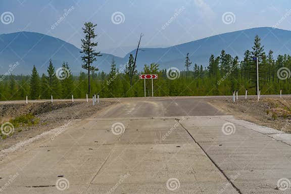 Rural Road Intersection with Forest and Mountains in the Background ...