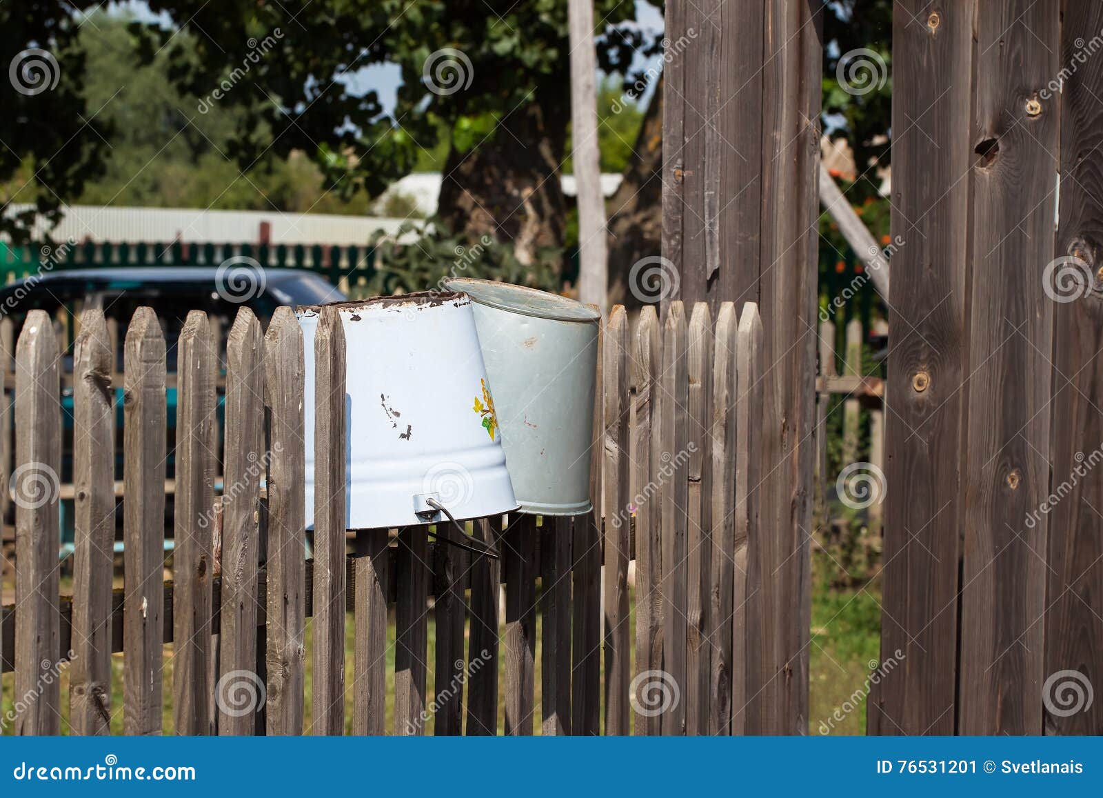 Rural Scenery - Old Rusty Buckets Hanging on a Wicker Fence Stock Image ...