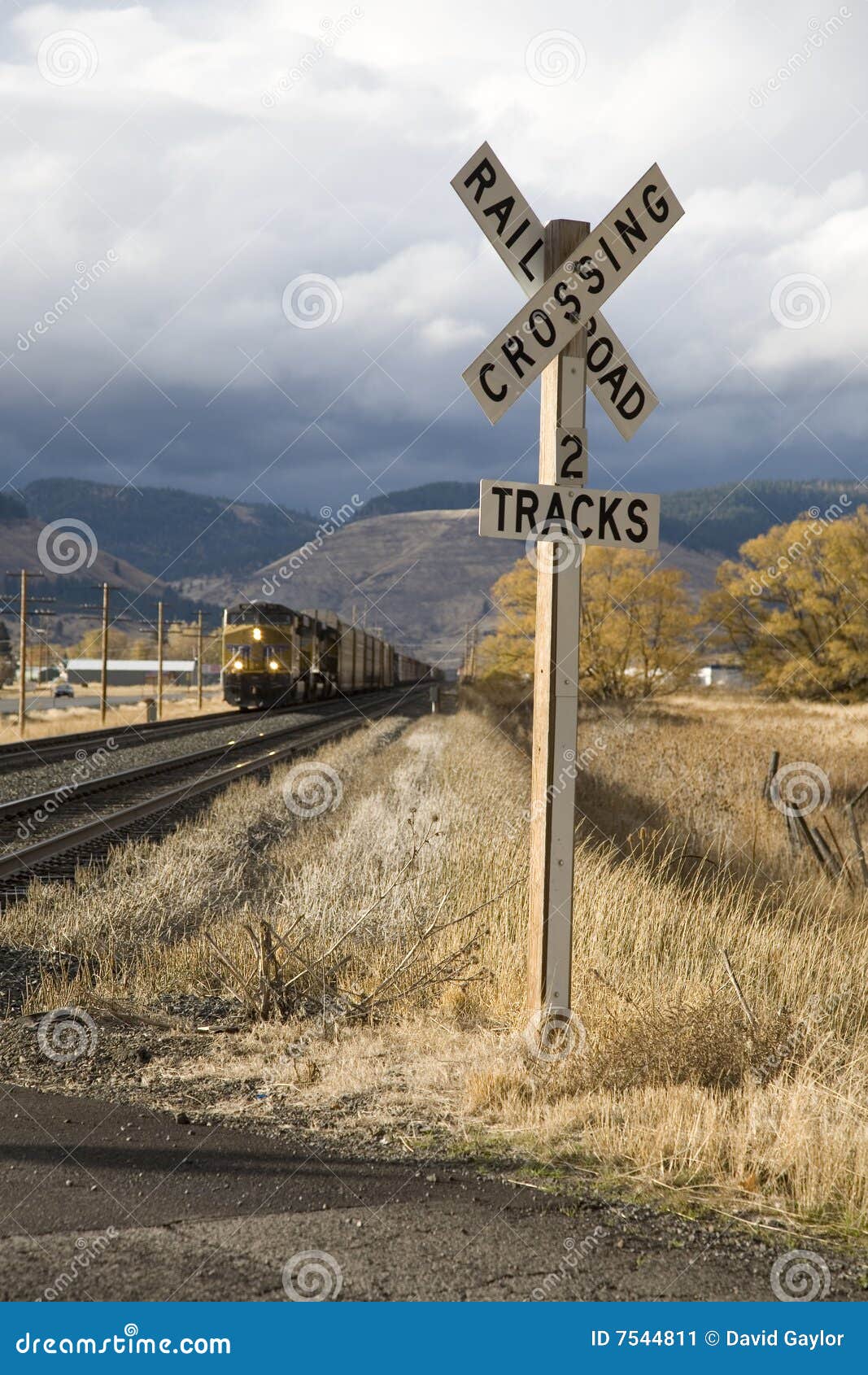 A Railroad Corssing With A Red Warning Sign And Warning Lamp And A ...