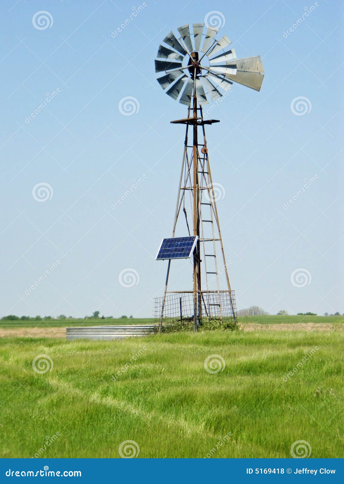 Rural Windmill Equipped with a Solar Panel Stock Photo - Image of field ...