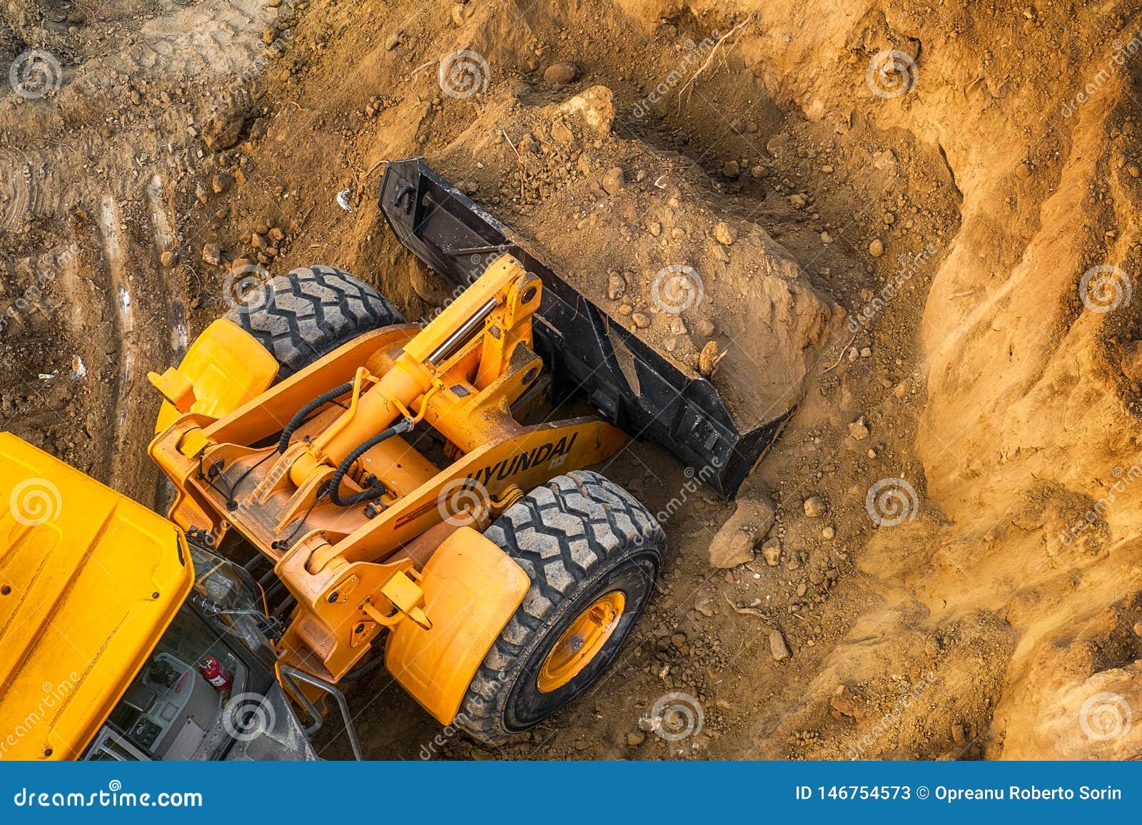The Modern Excavator Performs Excavation Work on the Construction Site ...