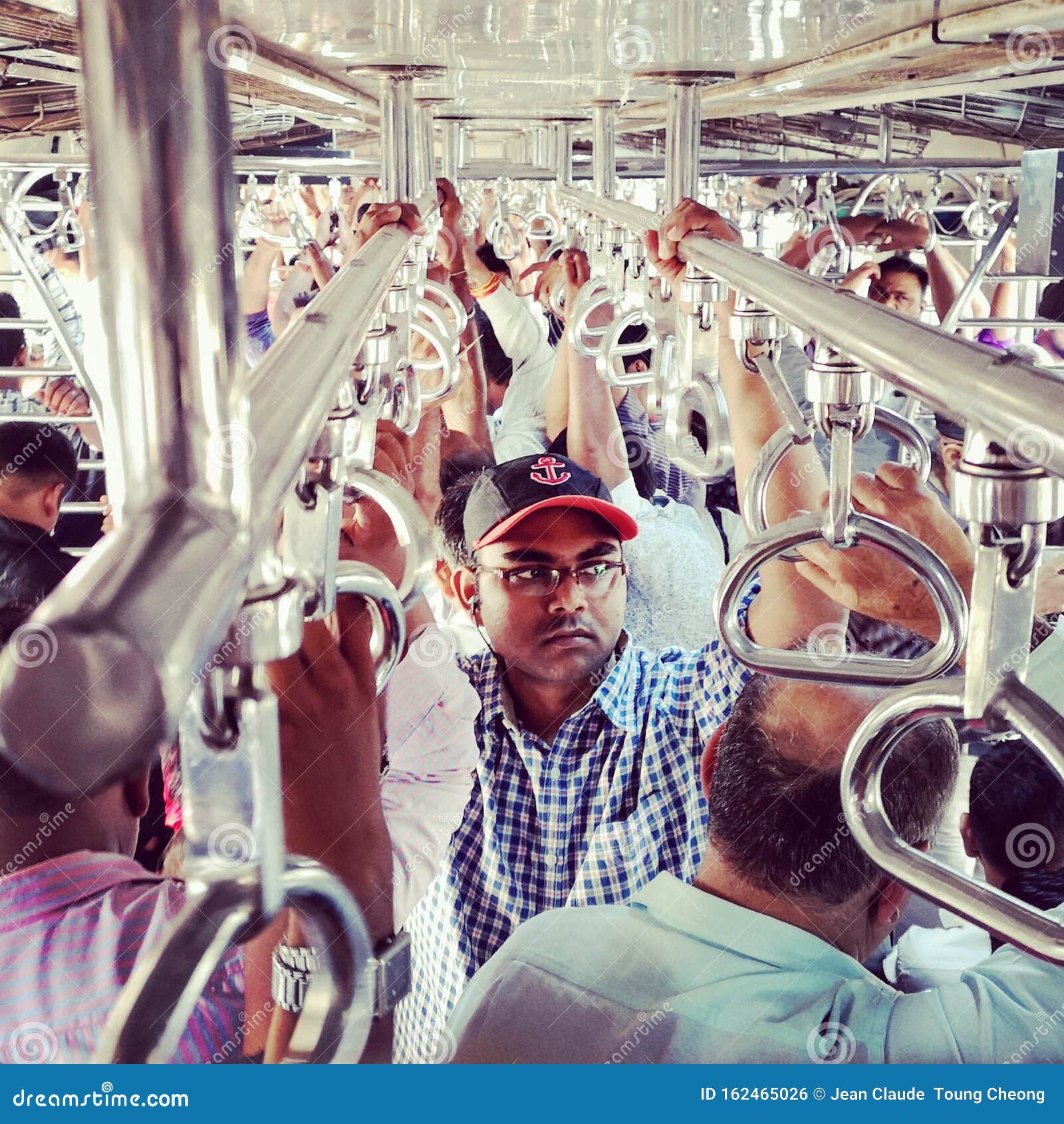 Rush Hour in Mumbai Local Train. Holding Tight To the Handrails ...