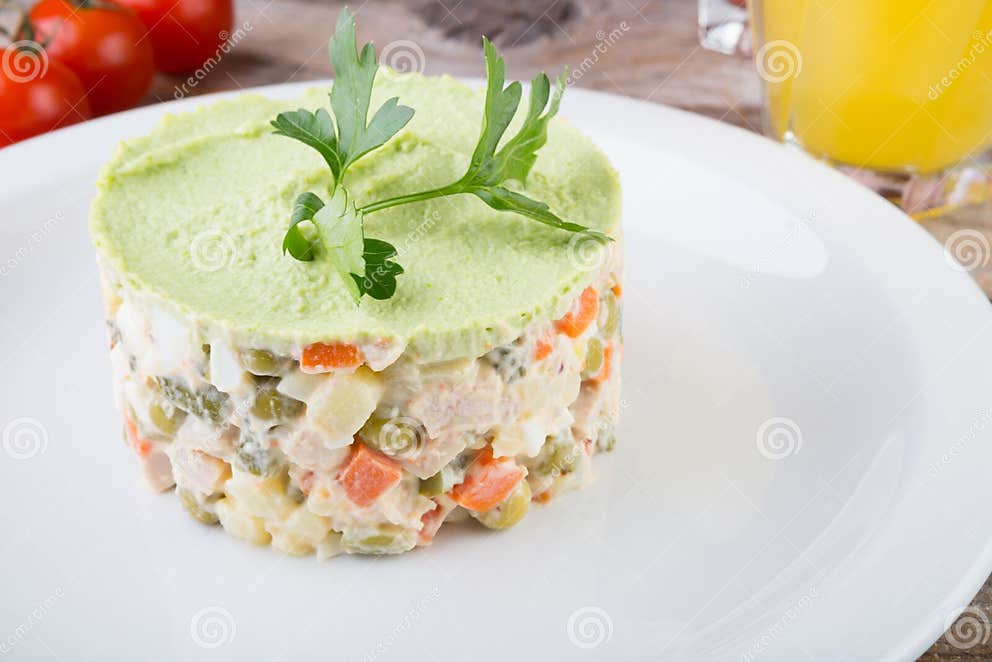 Russian salad on a plate stock photo. Image of garnish - 84841796